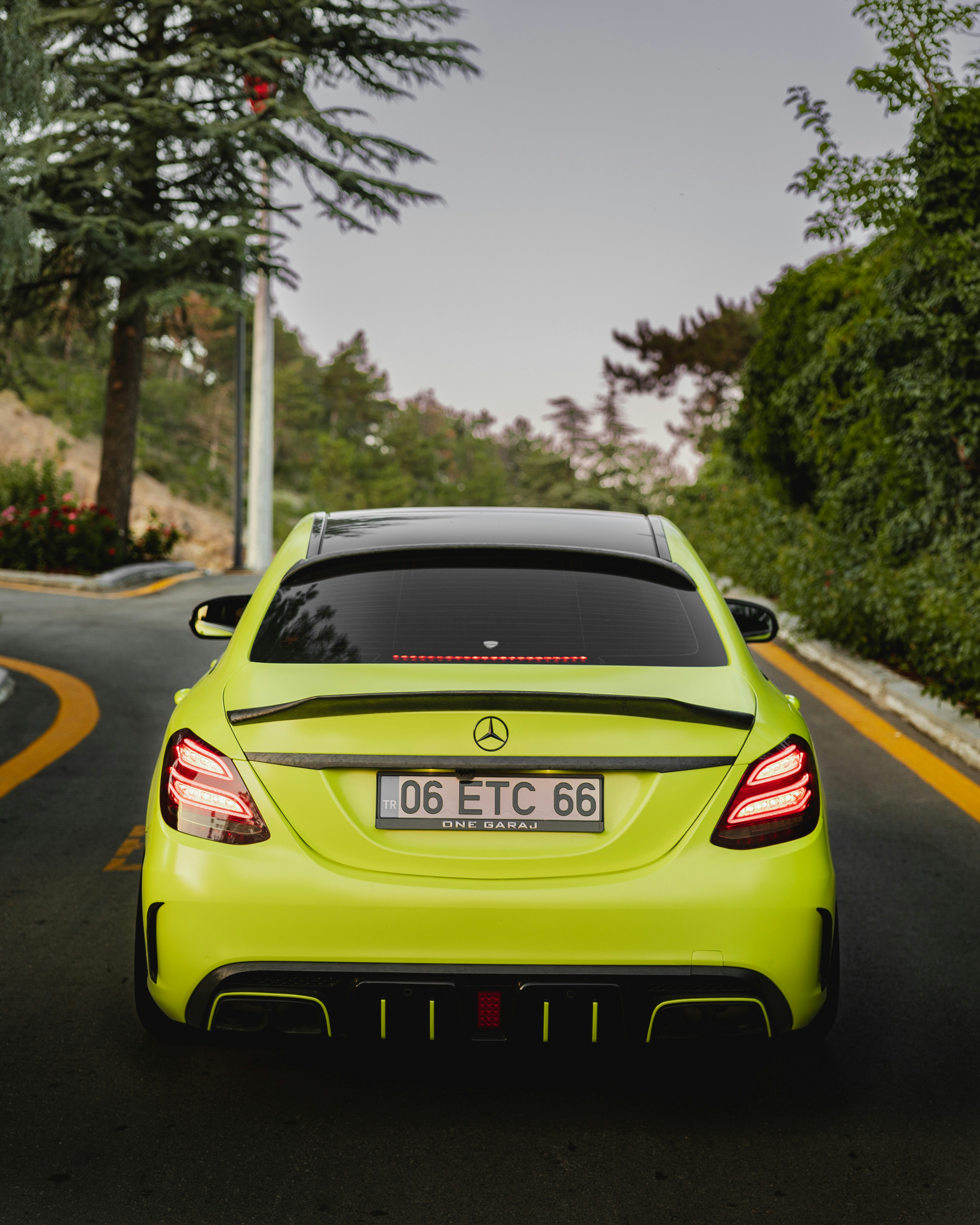 a yellow sports car on a road