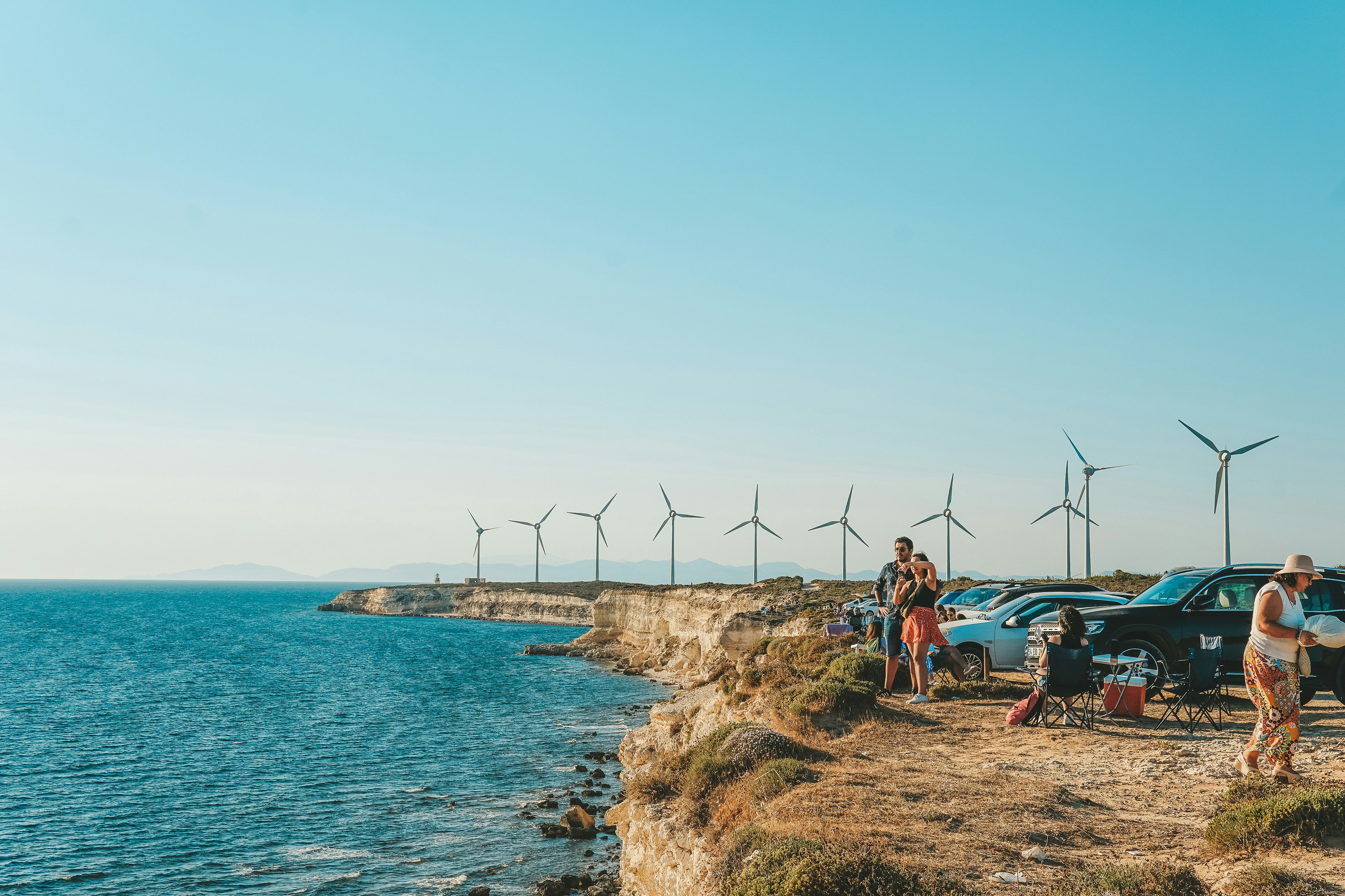 Cliffside Pause Under a Row of Wind Turbines