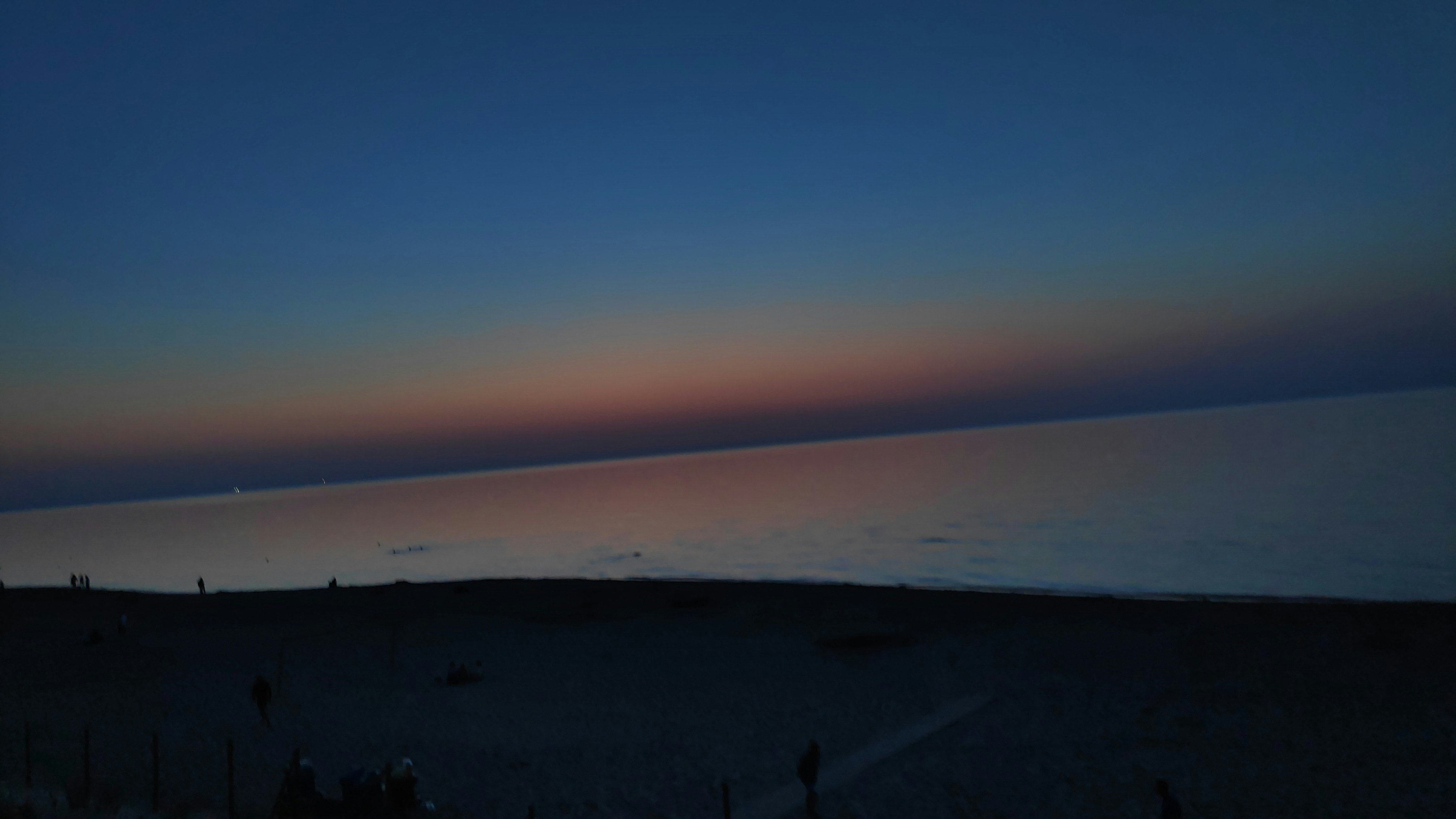 Twilight Shoreline: Quiet Horizon over Calm Waters