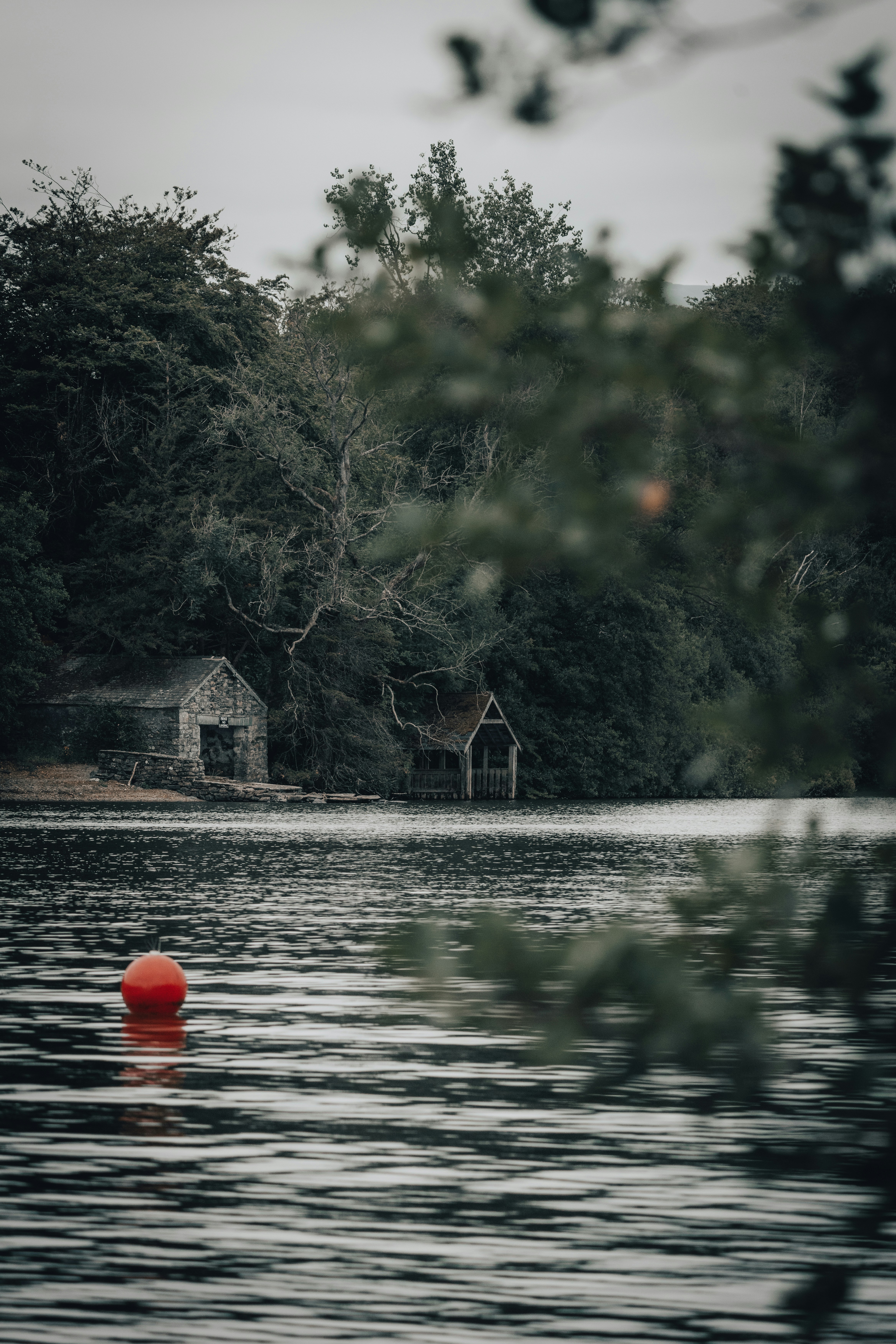 a house on a hill by a lake