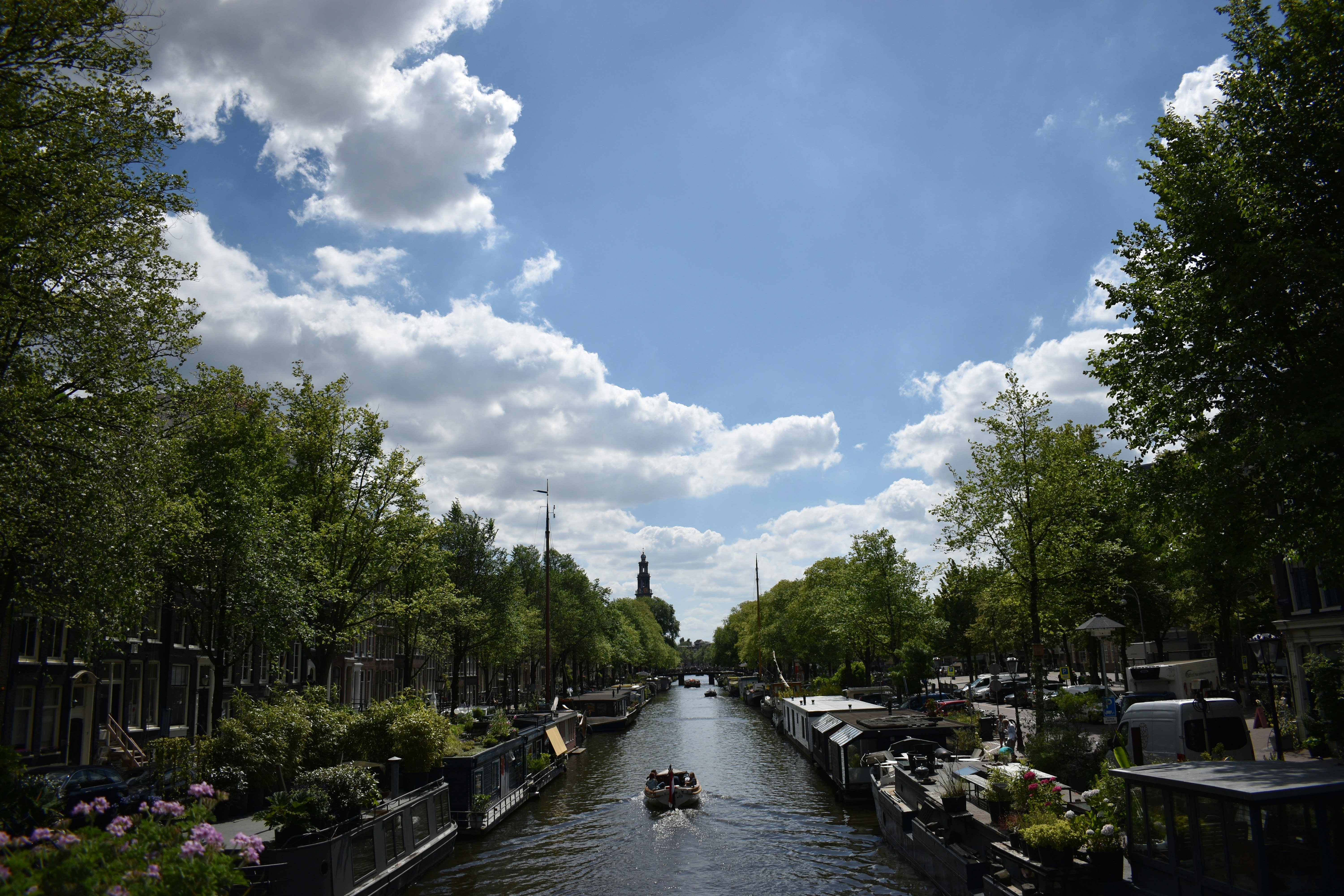 a river with boats on it and trees around it