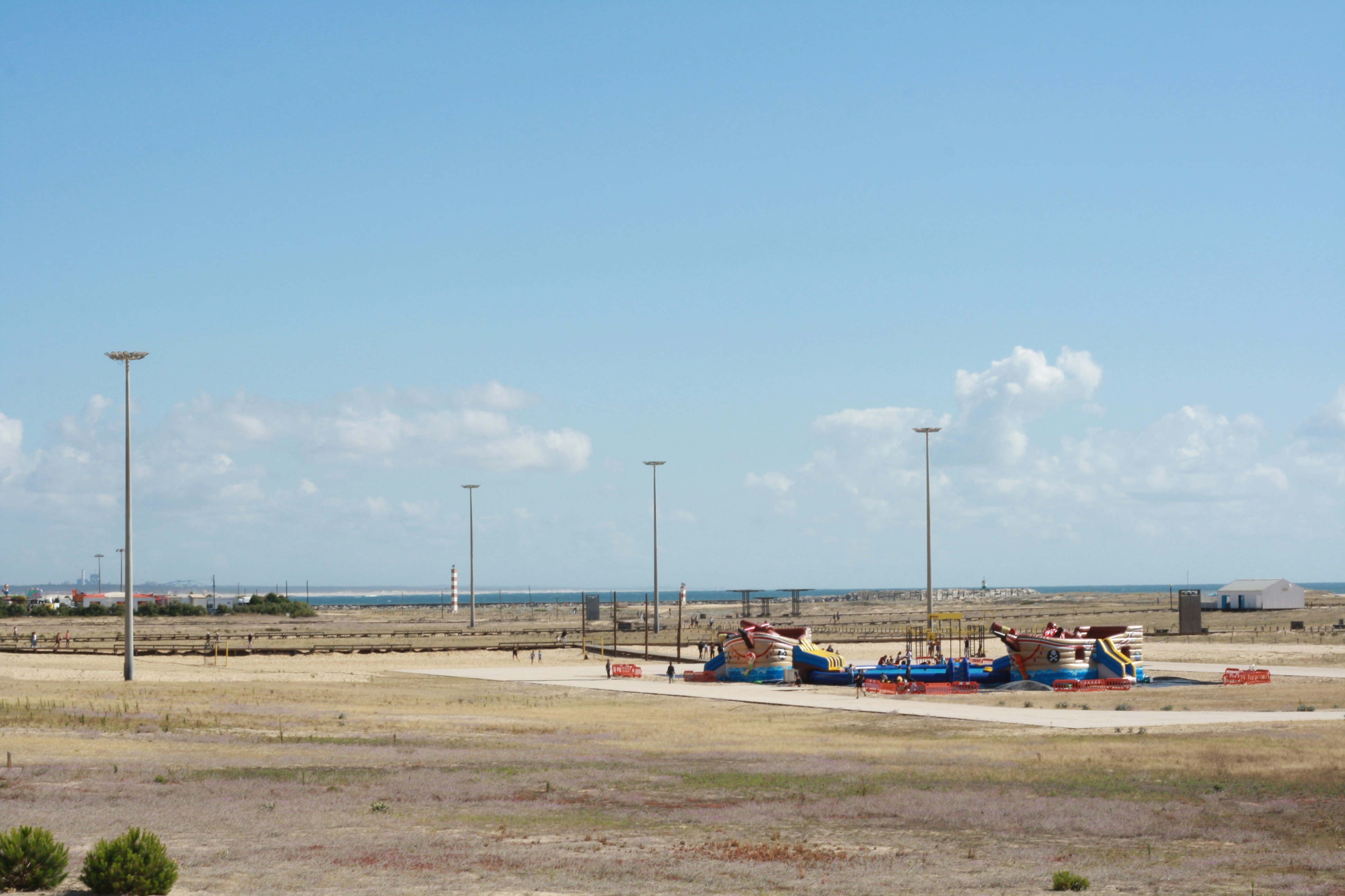 Pastel Rowboats at a Quiet Coastal Square Under a Wide Sky