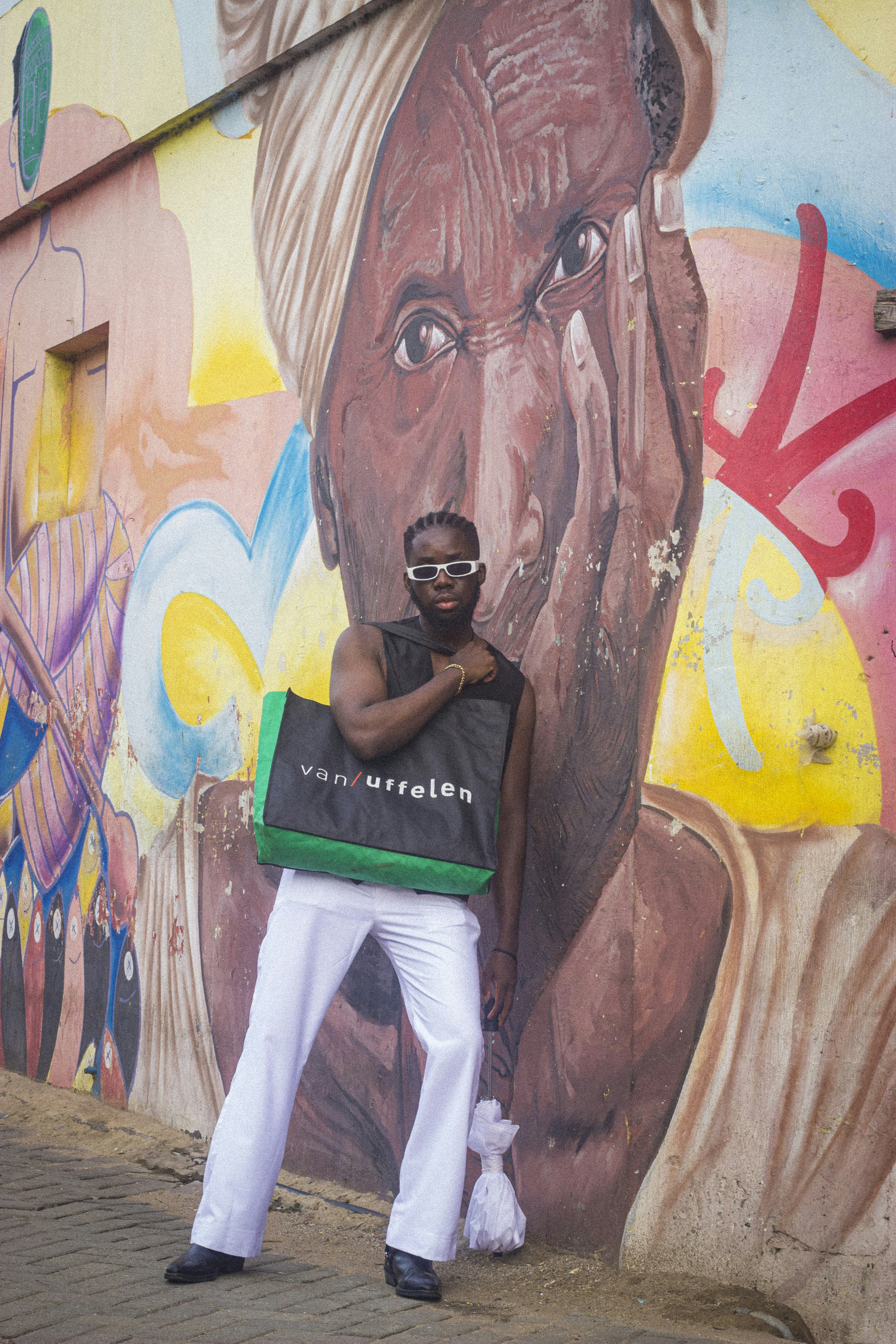 Urban Pose in Front of Graffitied Portrait