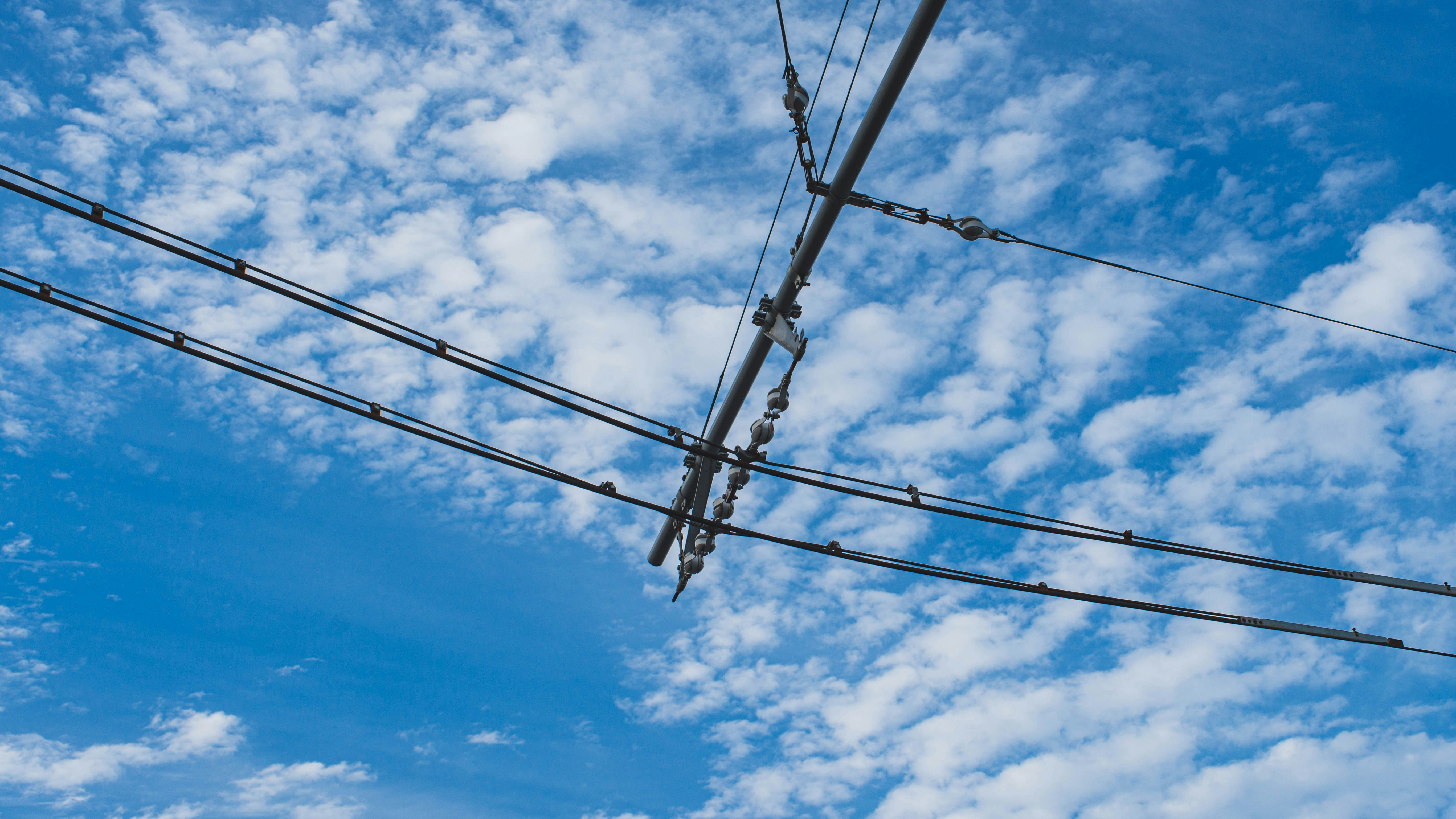 Convergence in the Sky: A Geometric Web of Cables Against a Cerulean Canvas