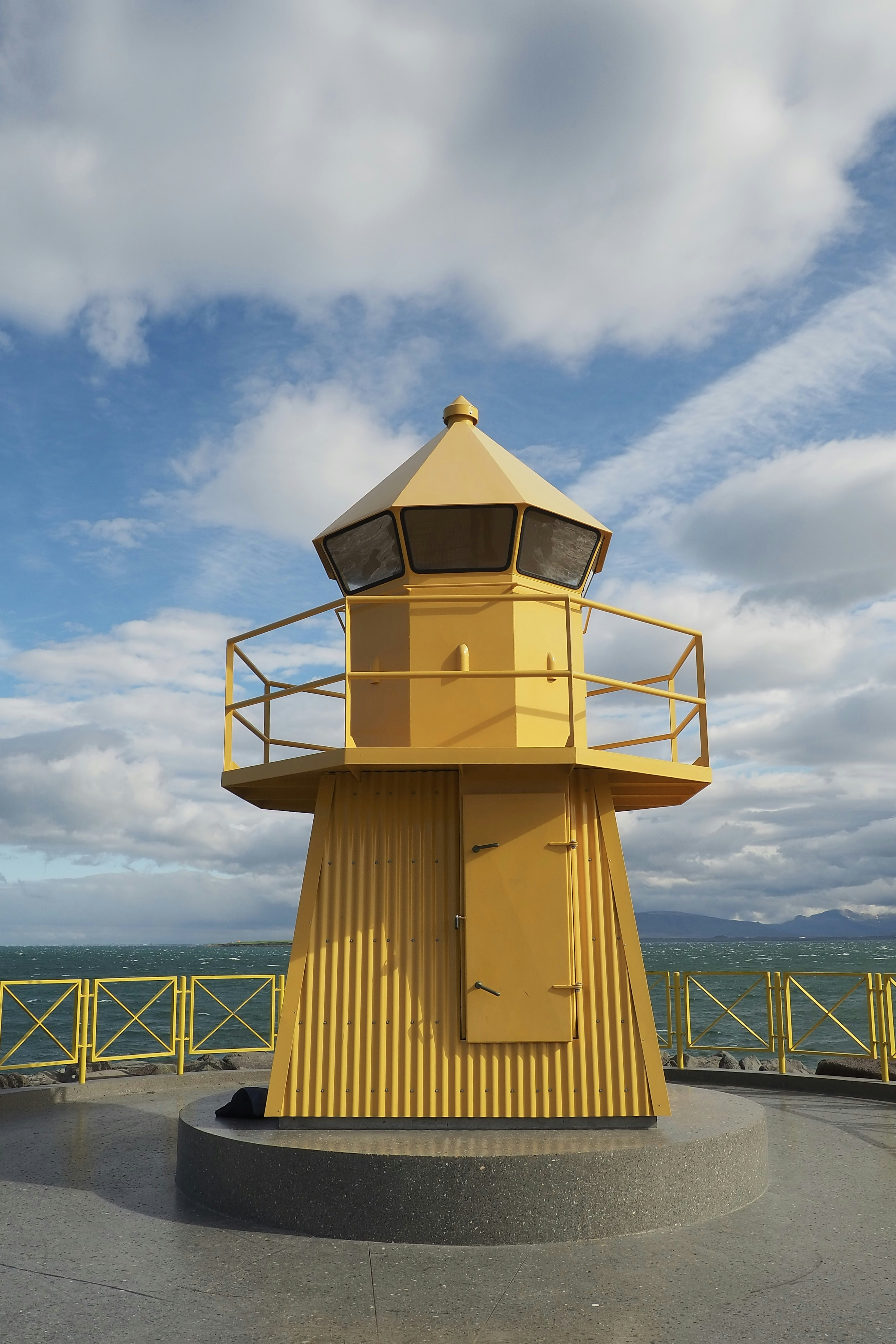 Sunward Sentinel: A Bold Yellow Tower Guards the Seafront