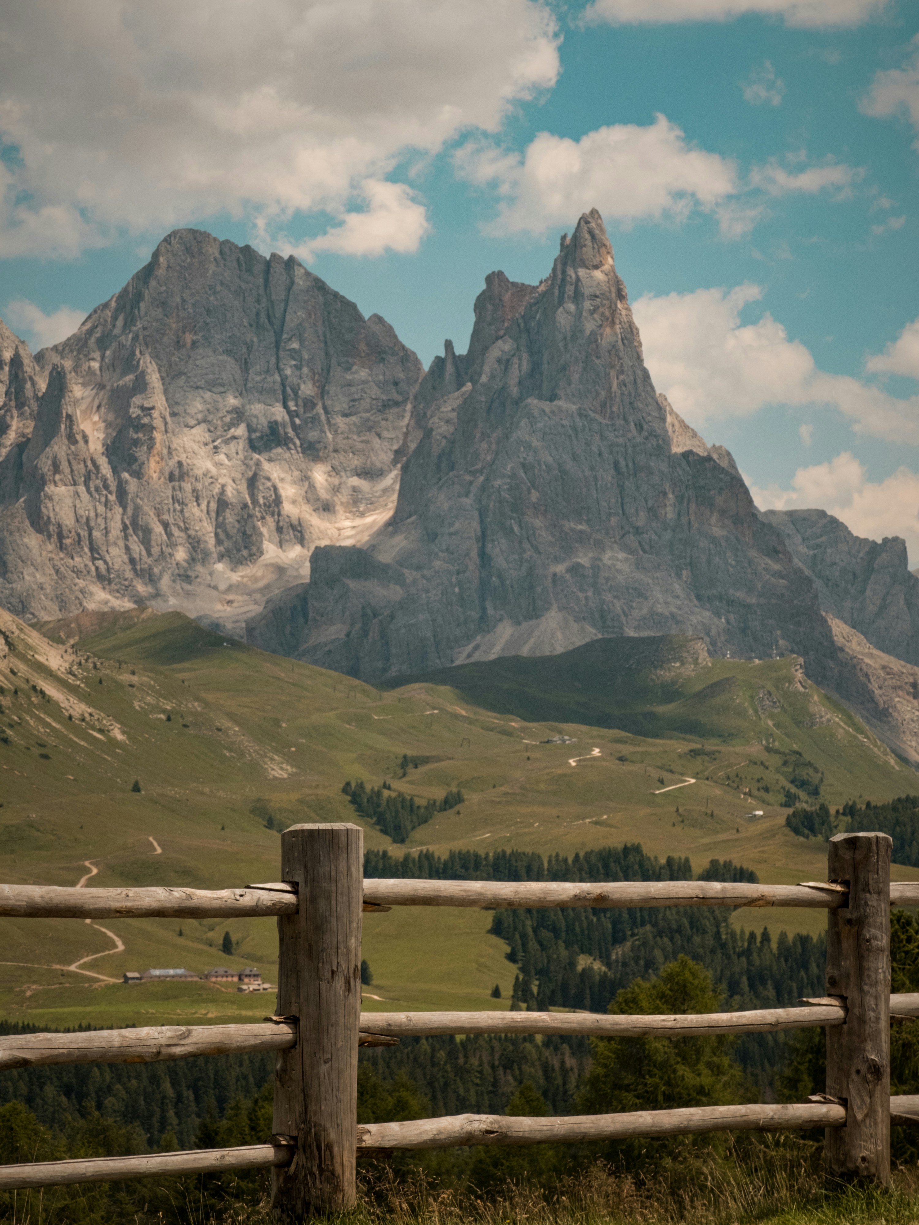 Jagged Peak Over Alpine Meadows, Framed by a Weathered Fence
