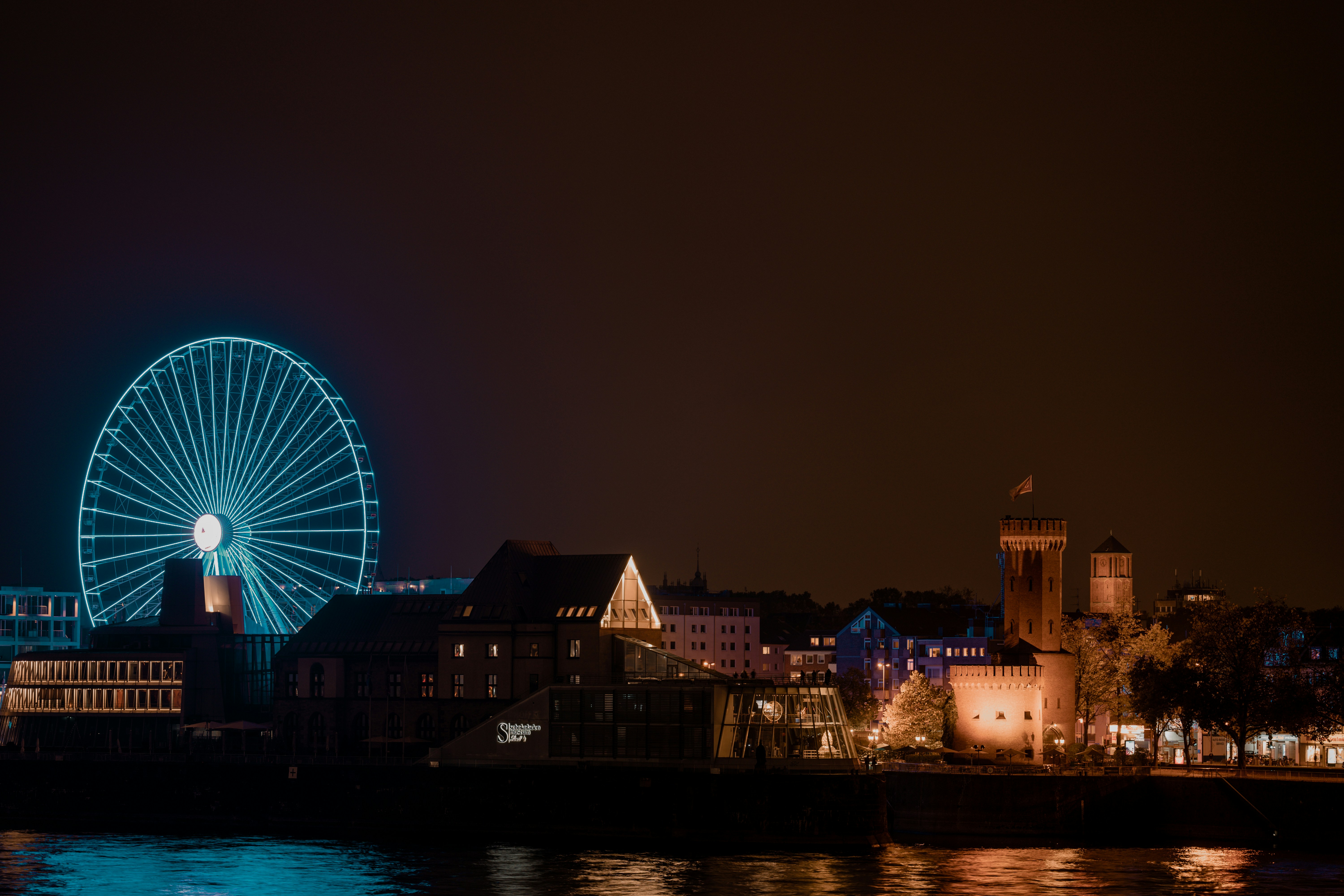 Moonlit Ribble: A Ferris Wheel Glows Over a Calm Riverfront