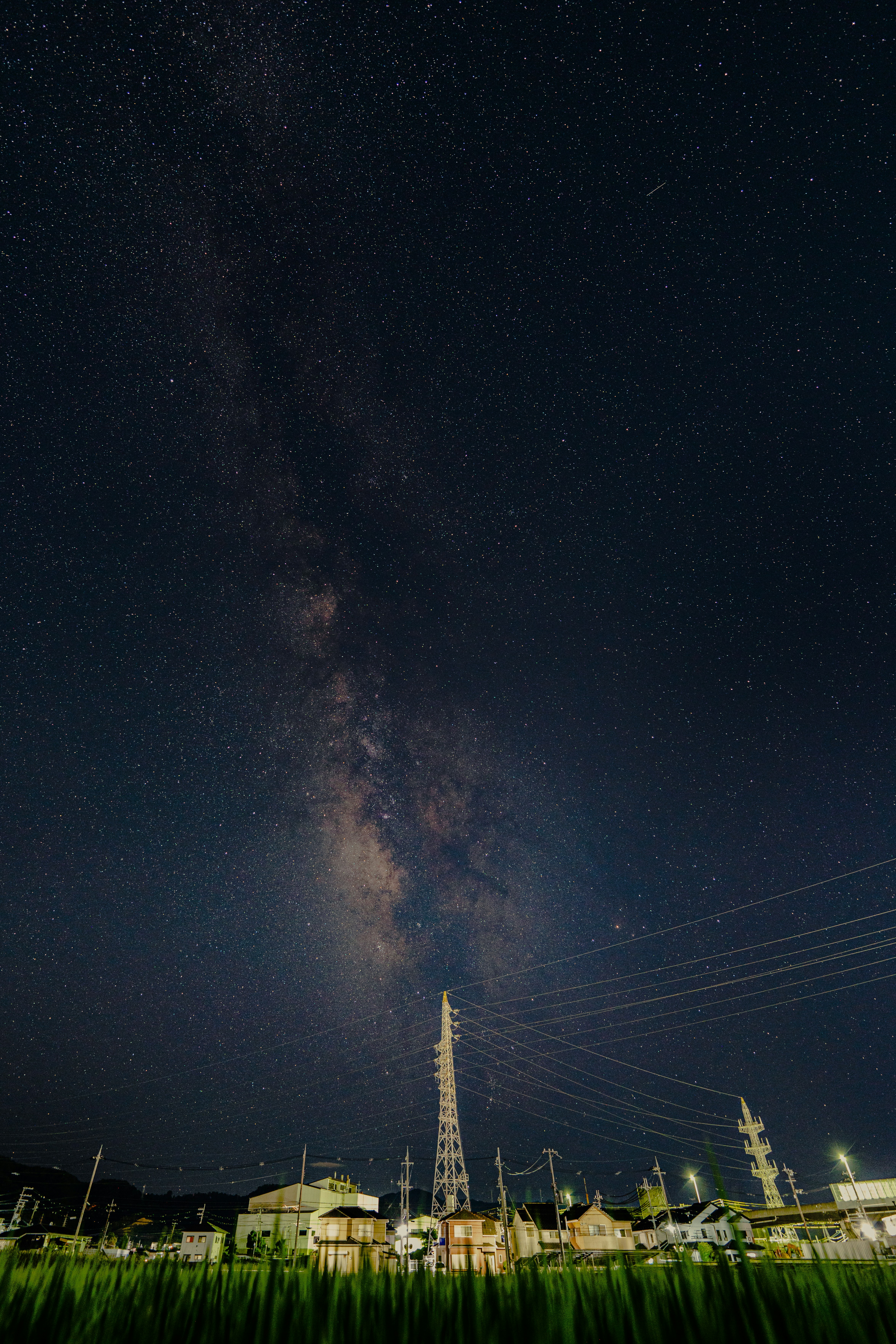Milky Way Core Over a Quiet Town with Electric Threads