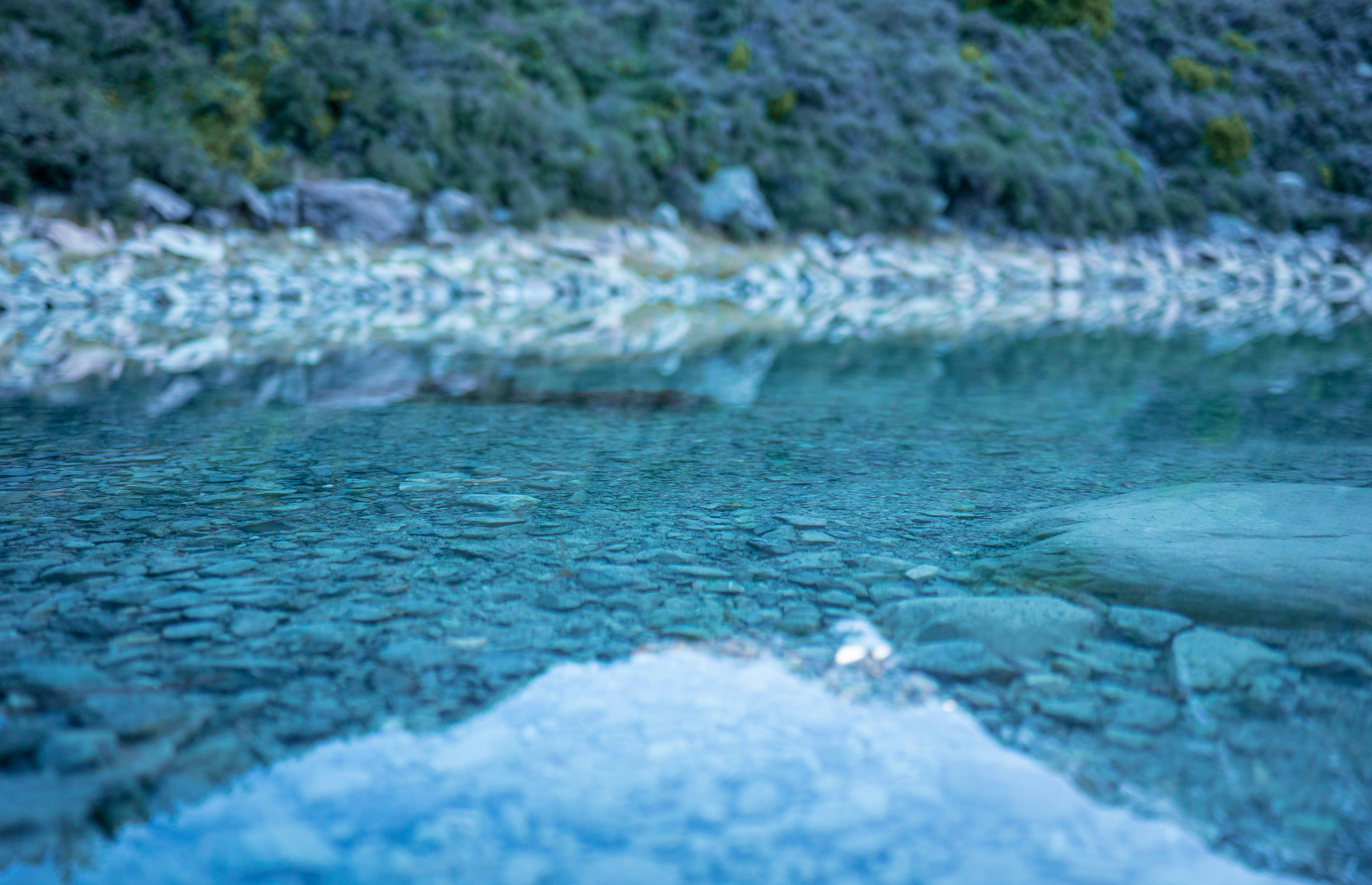 Glacial Pool at Dusk: Clear Waters Meeting a Rocky Shore