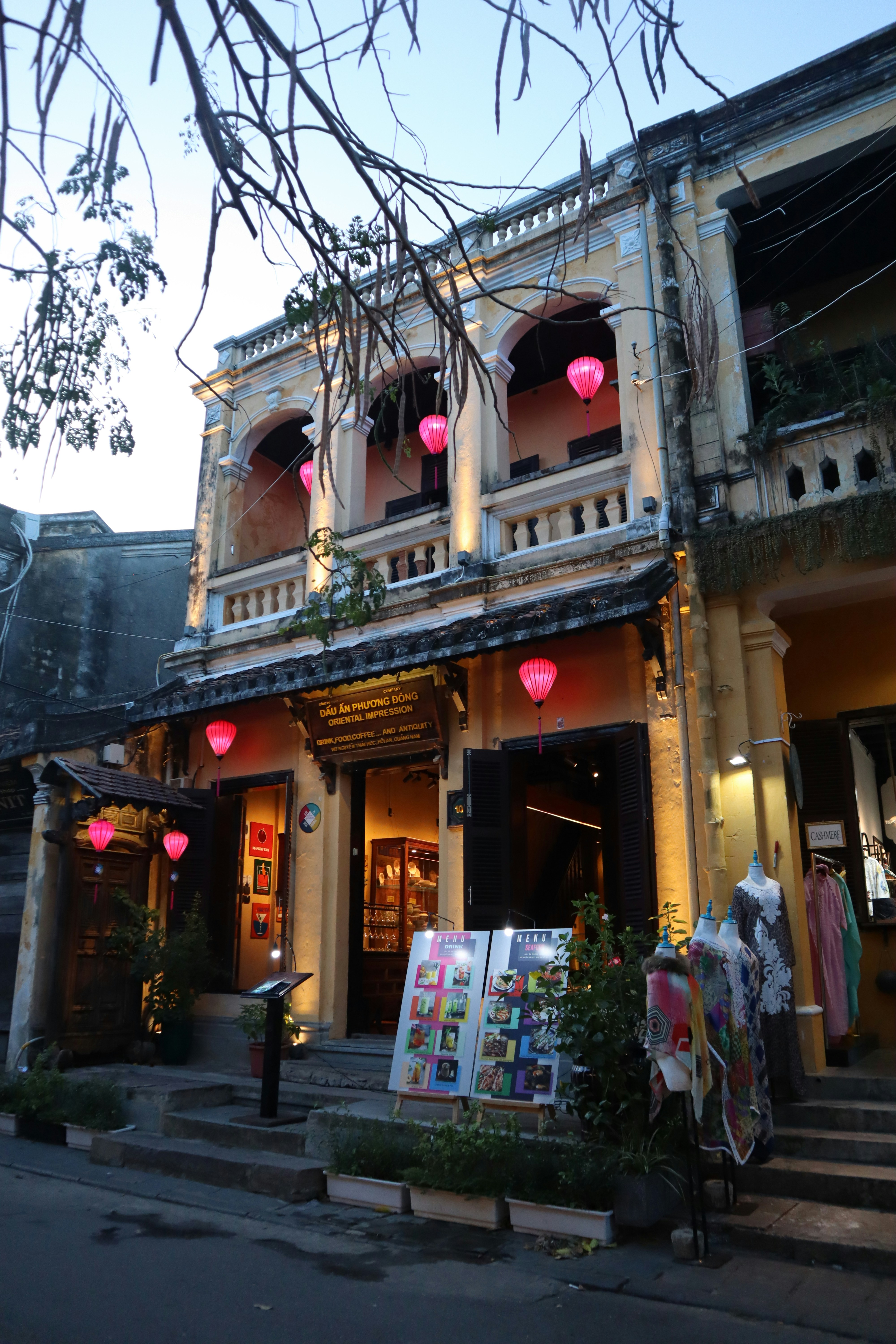Crimson Lanterns Crown an Arcaded Streetfront at Dusk