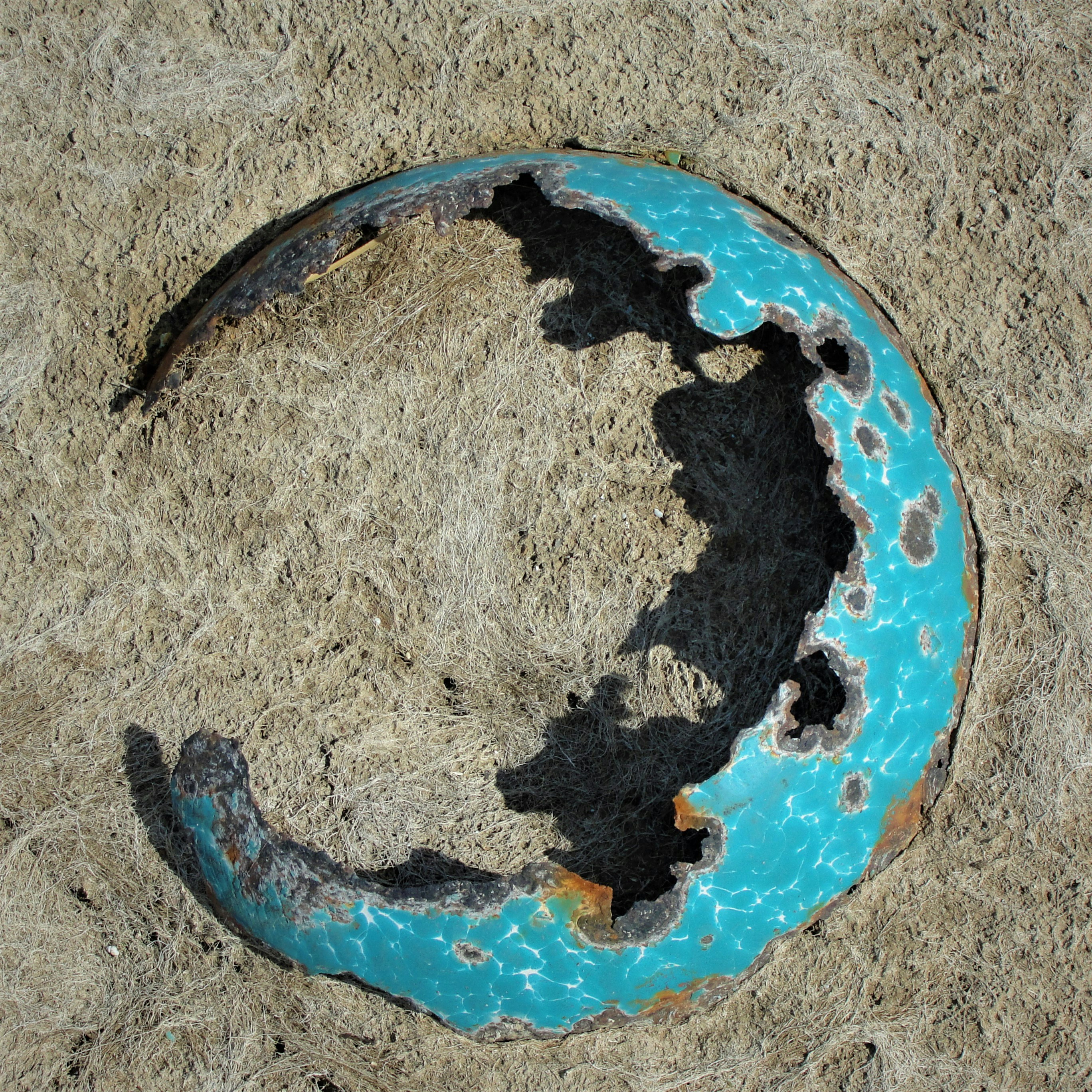 Old enamel bowl found on the shore of a salt lake 