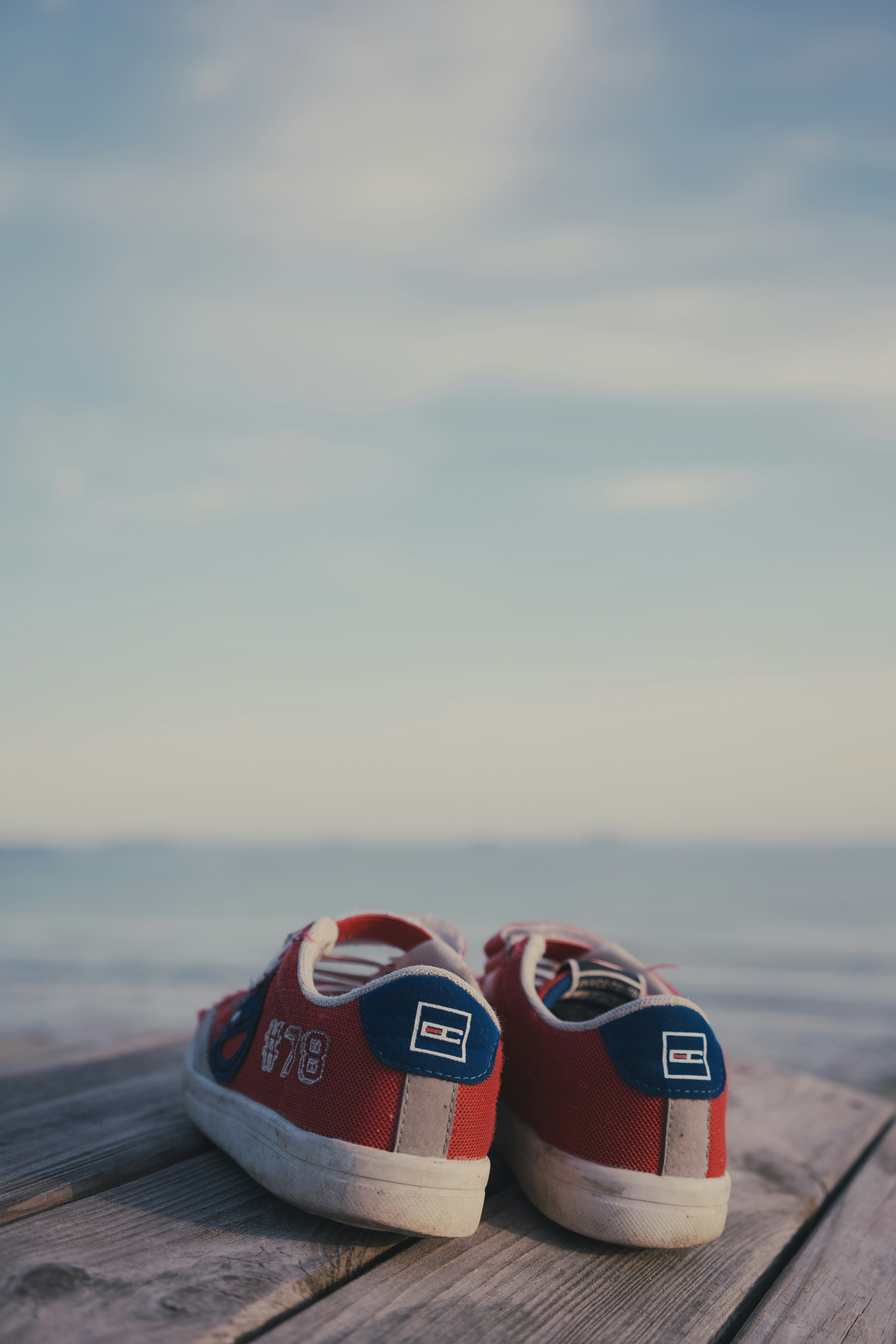 A group of shoes on a wood surface photo – Free Grey Image on Unsplash