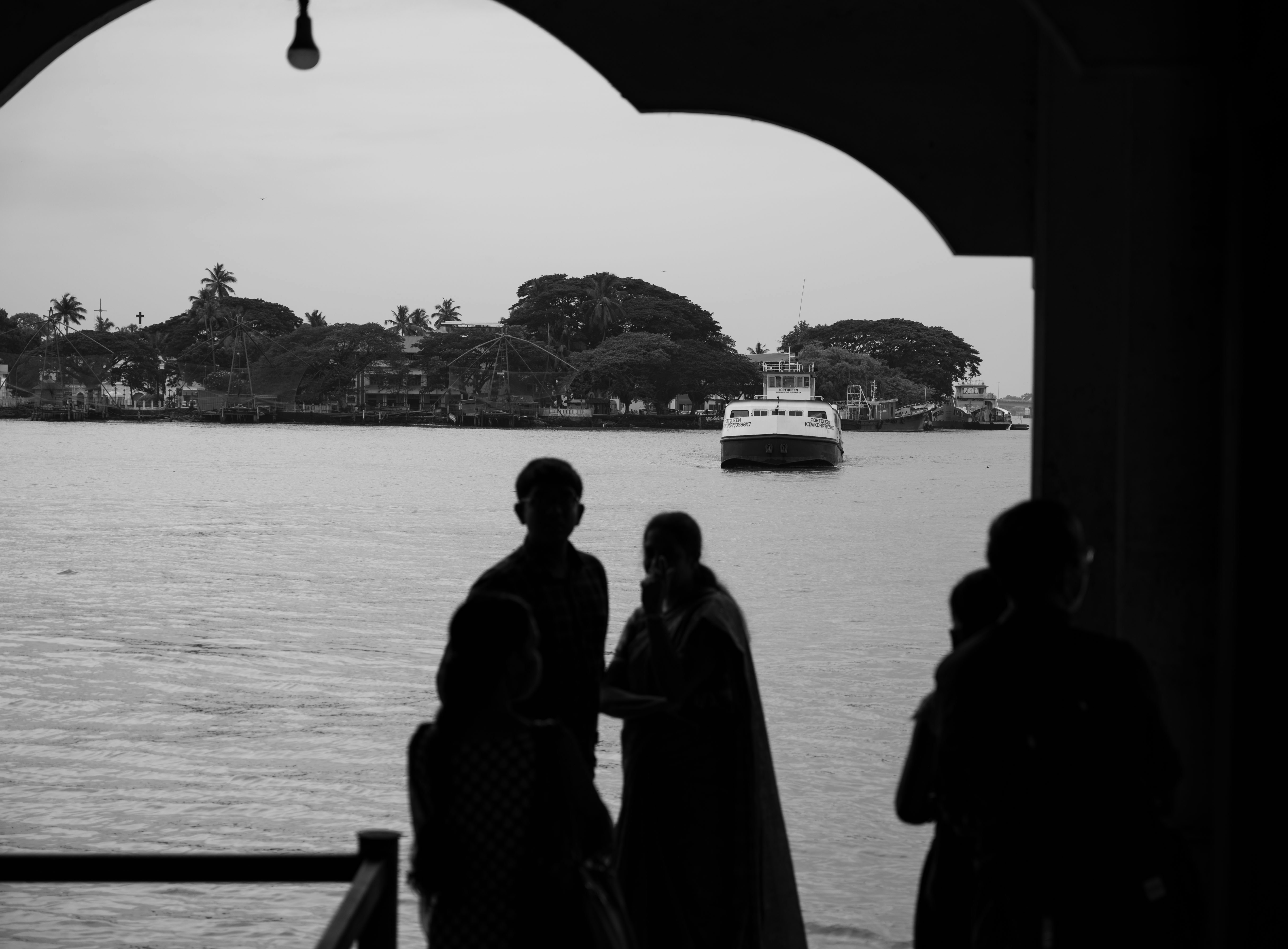 Silhouetted Gatherers at Dusk by the Waterfront