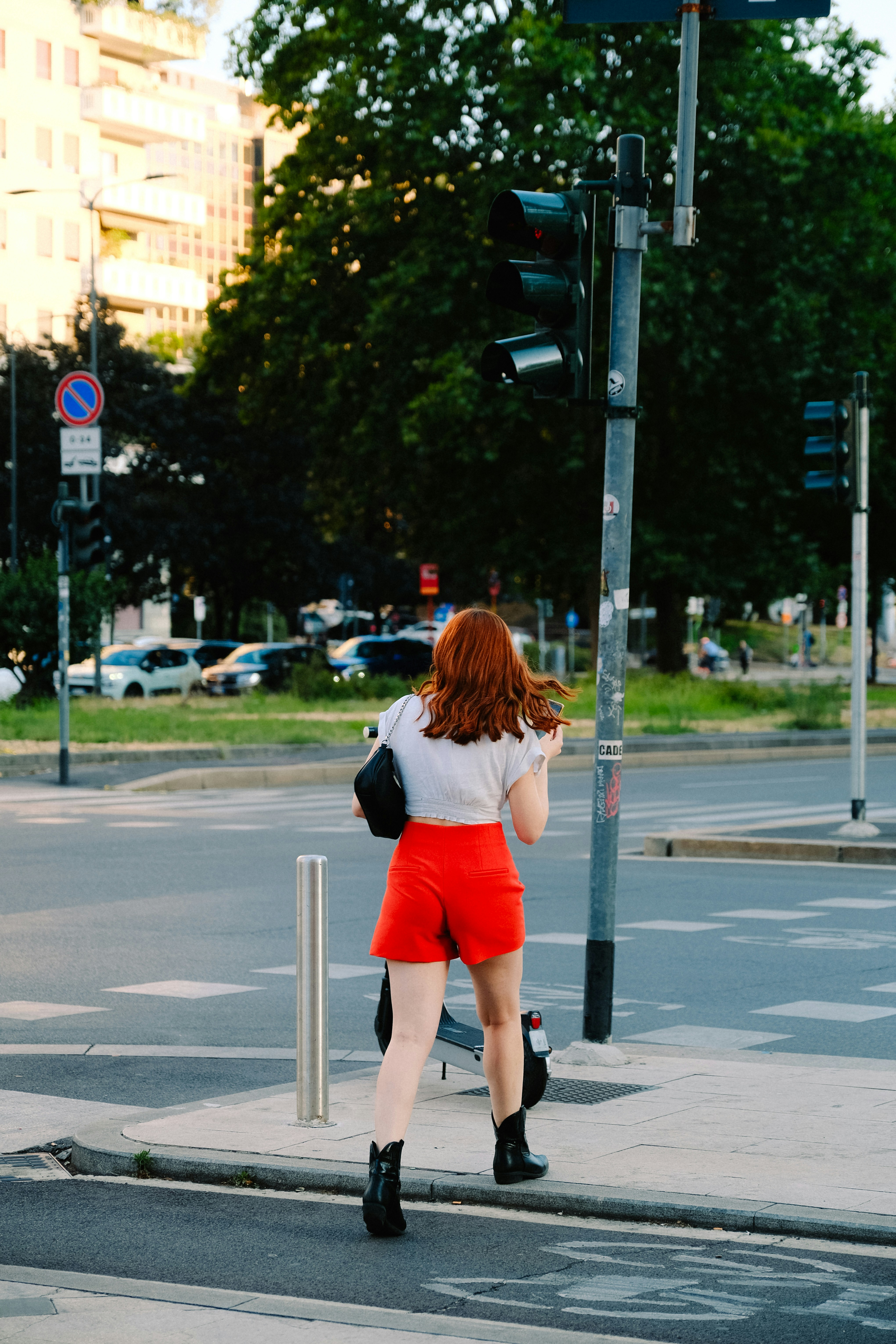 Scarlet Crossing: A City Pedestrian in Red Shorts