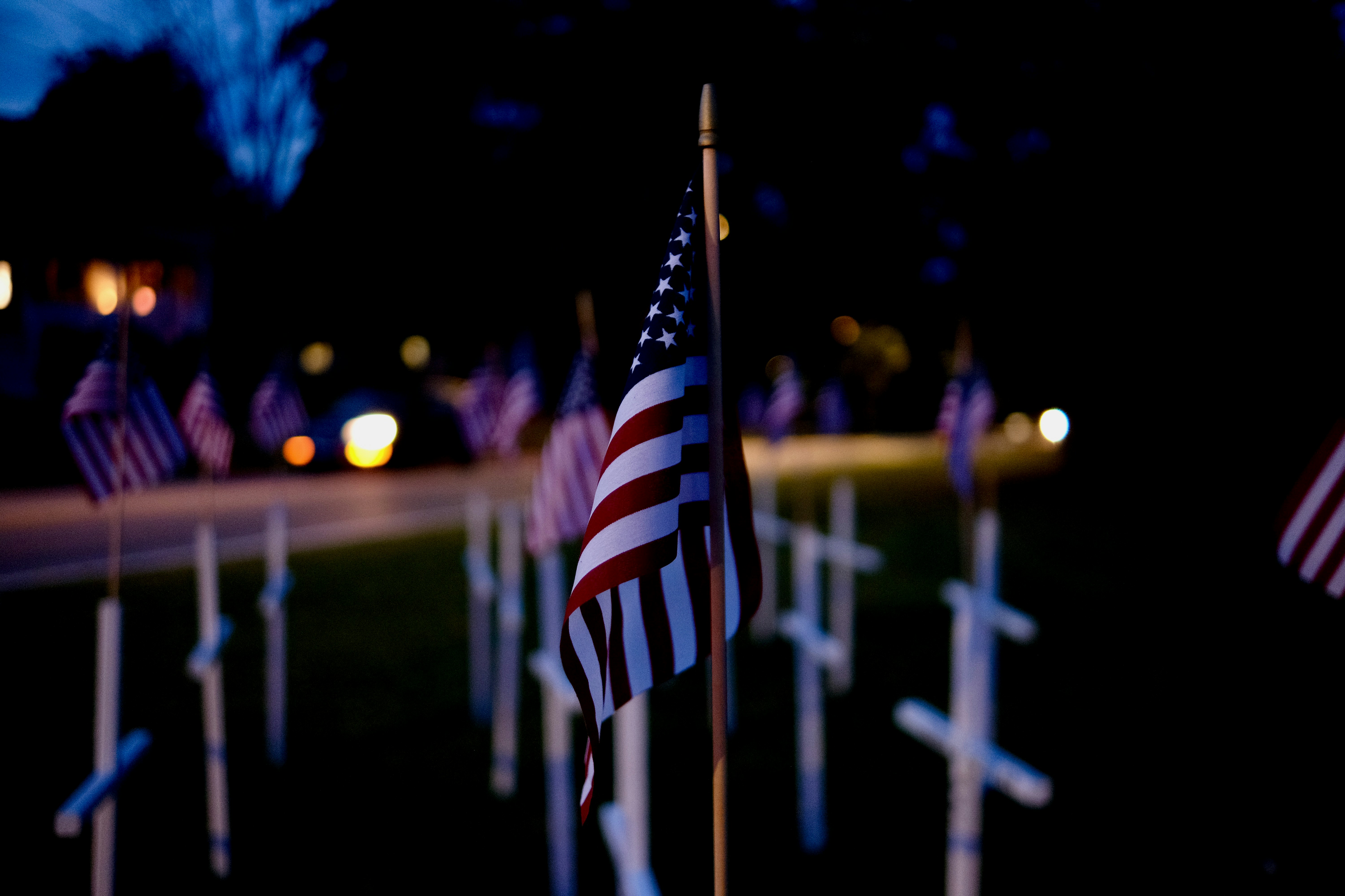 Small flag on memorial day display of crosses for fallen soldiers