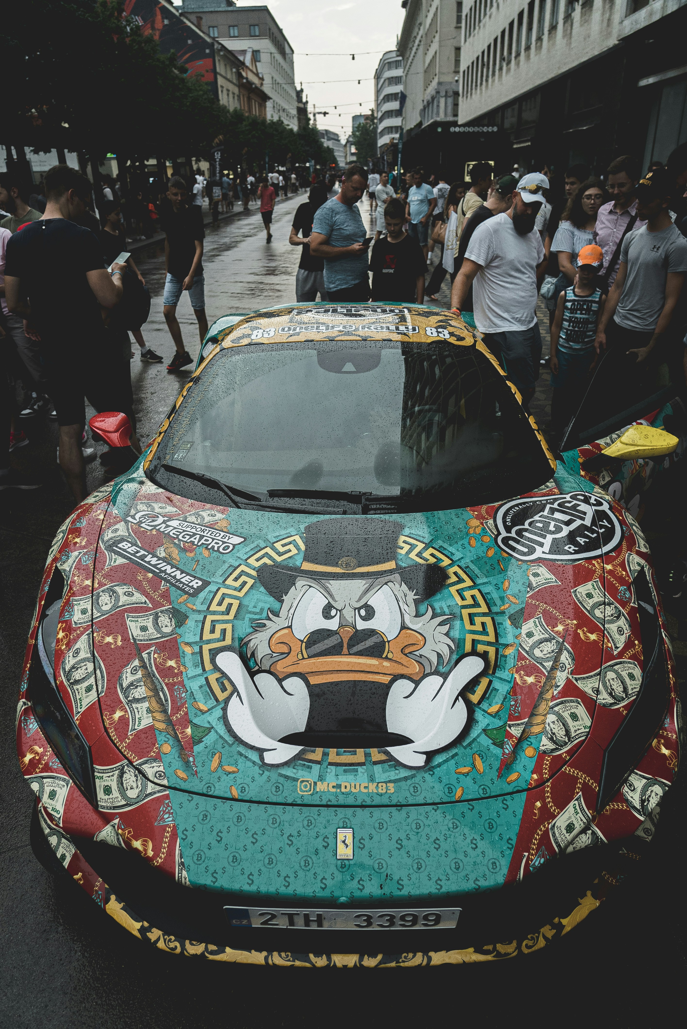 Dollar Duck Car Wrap at a Bustling City Street Festival