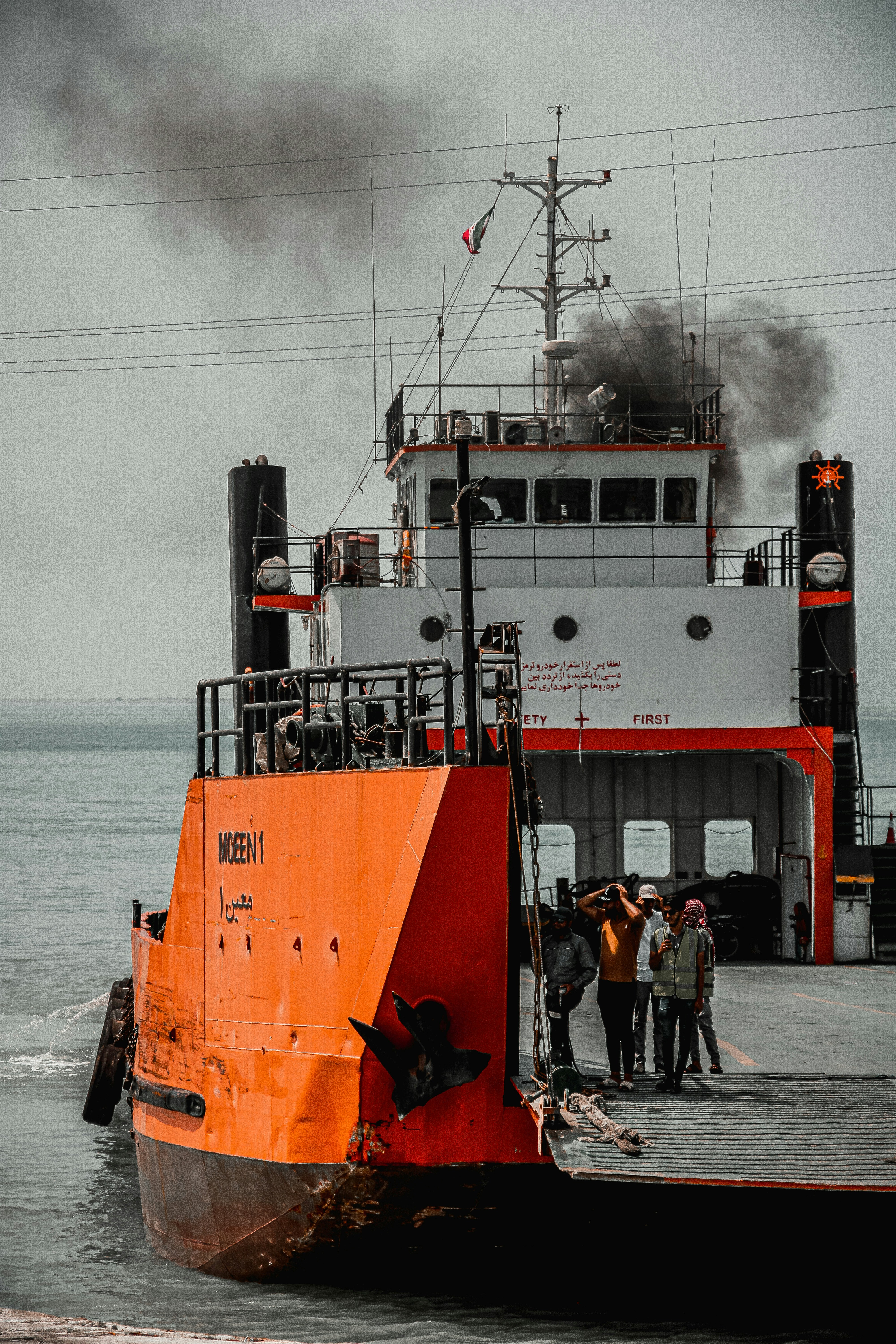 The Orange Hull and the Quiet Voyage: Passengers at the Ferryfront
