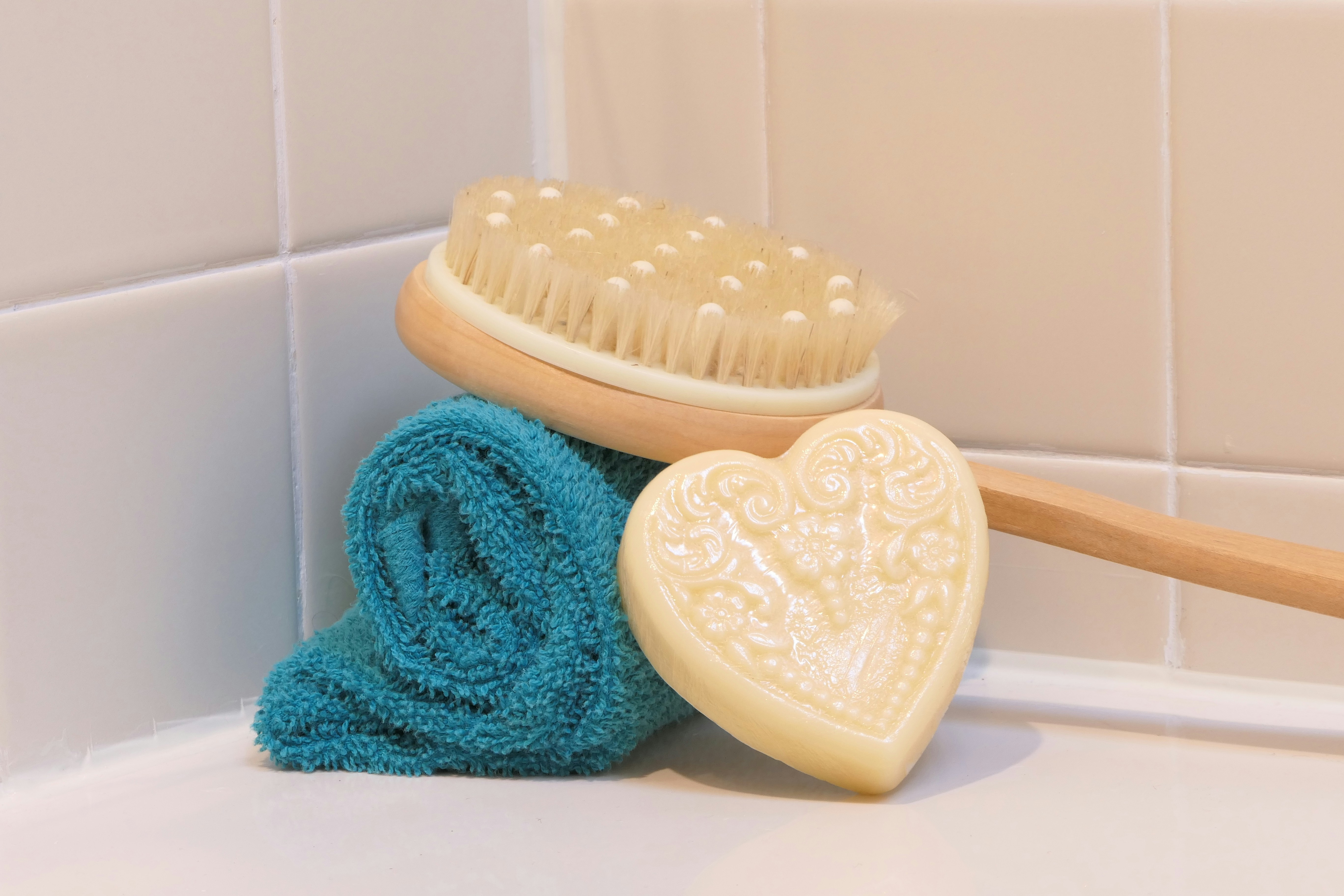 bath and shower accessories | a couple of eggs with a towel on a shelf