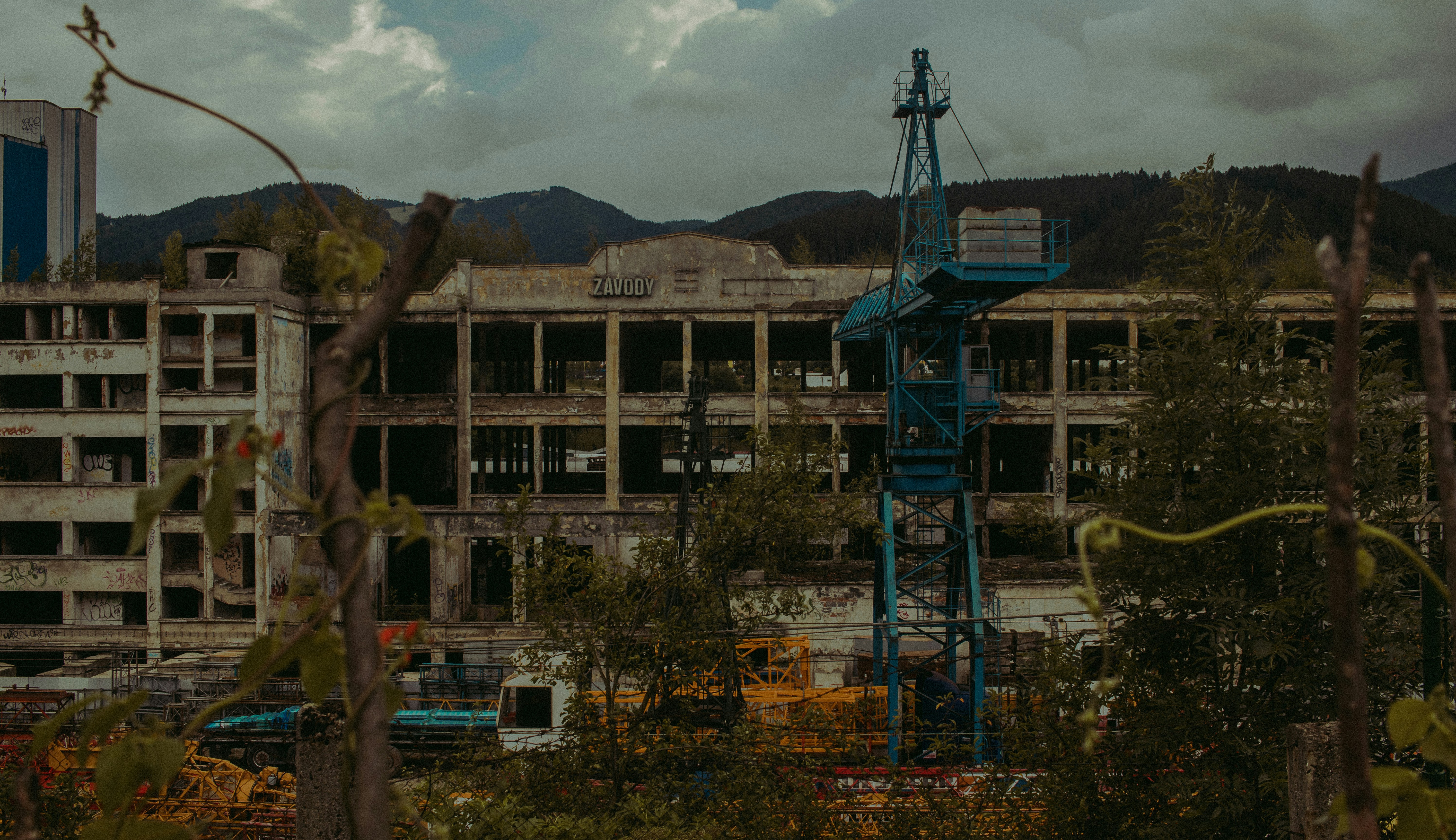 Crane and Crumbled Facade: A Distant Construction Scene