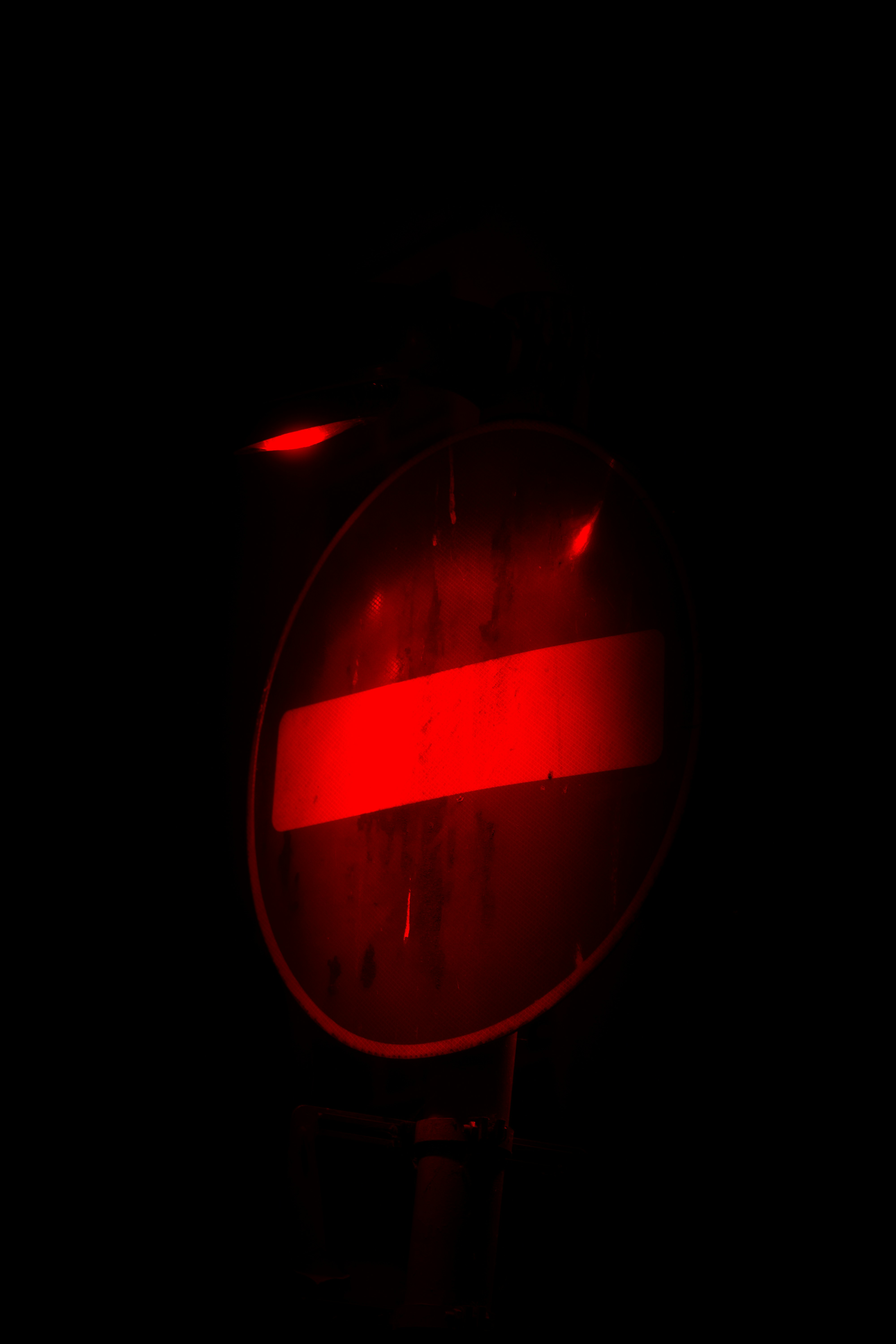 Red Bar Across the Night: A Noisy Stop Sign in Darkness