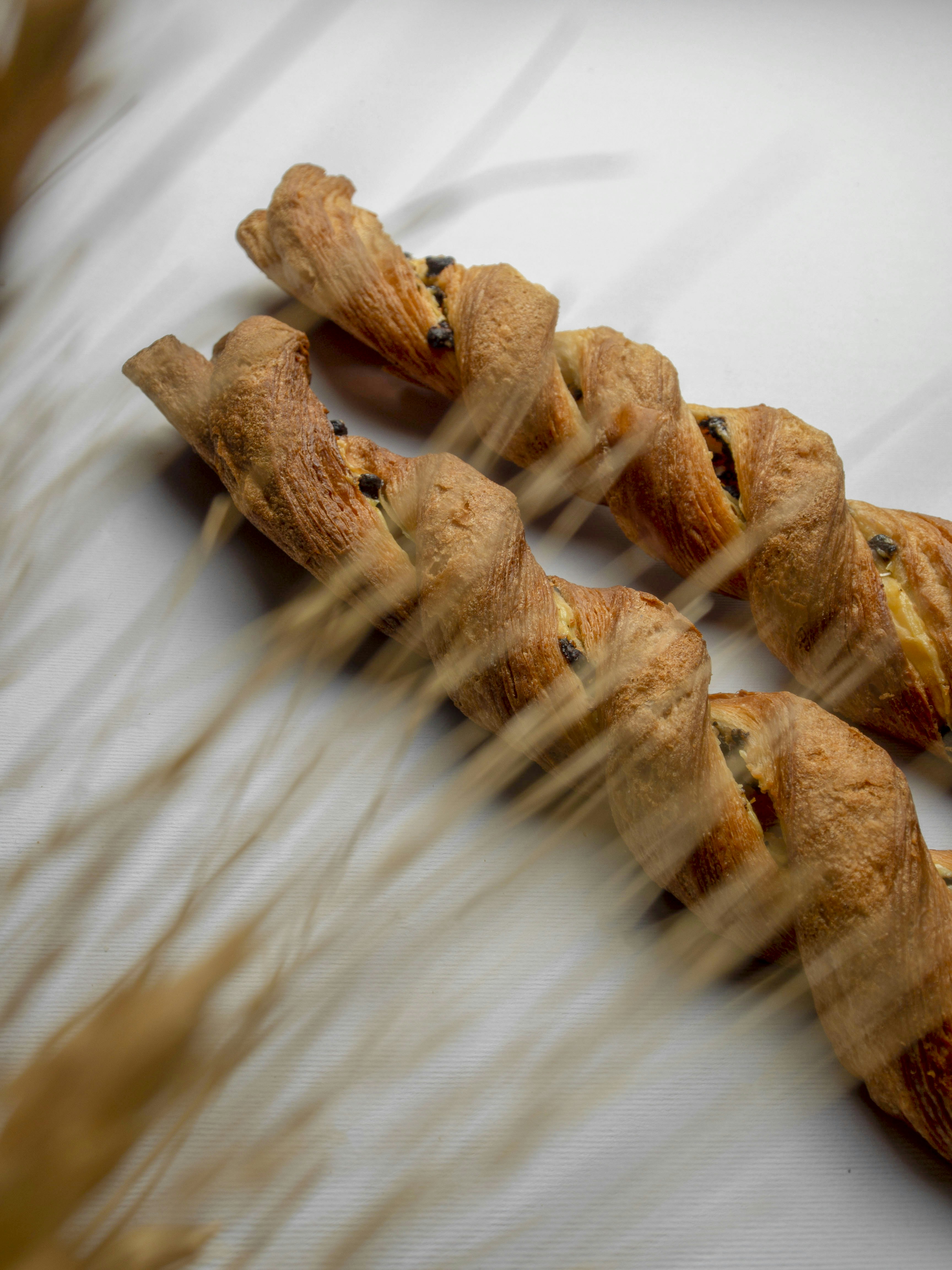 Twisted pastry loaves in soft focus foreground
