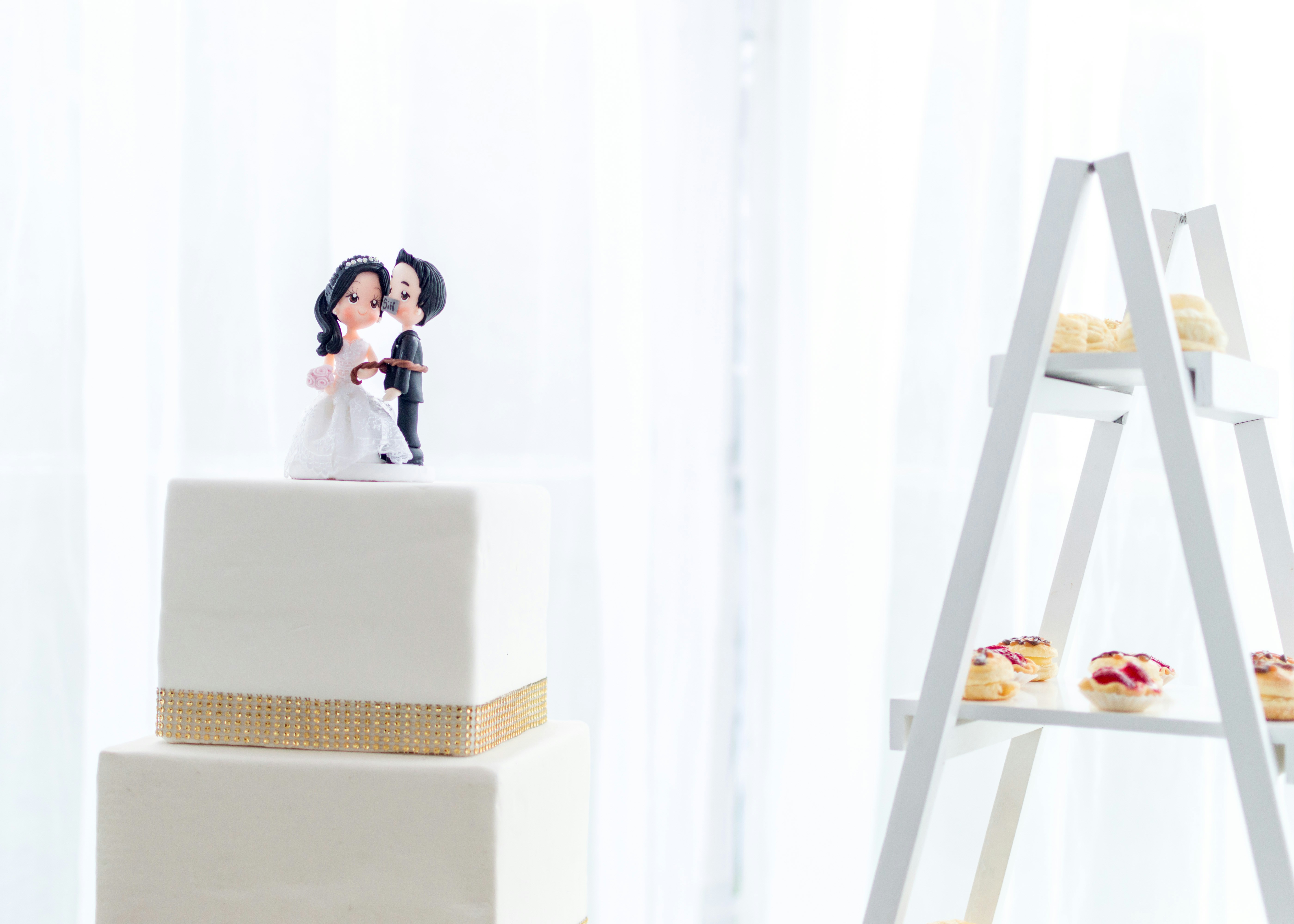 Bride-and-Groom Topper on a Minimalist White Cake