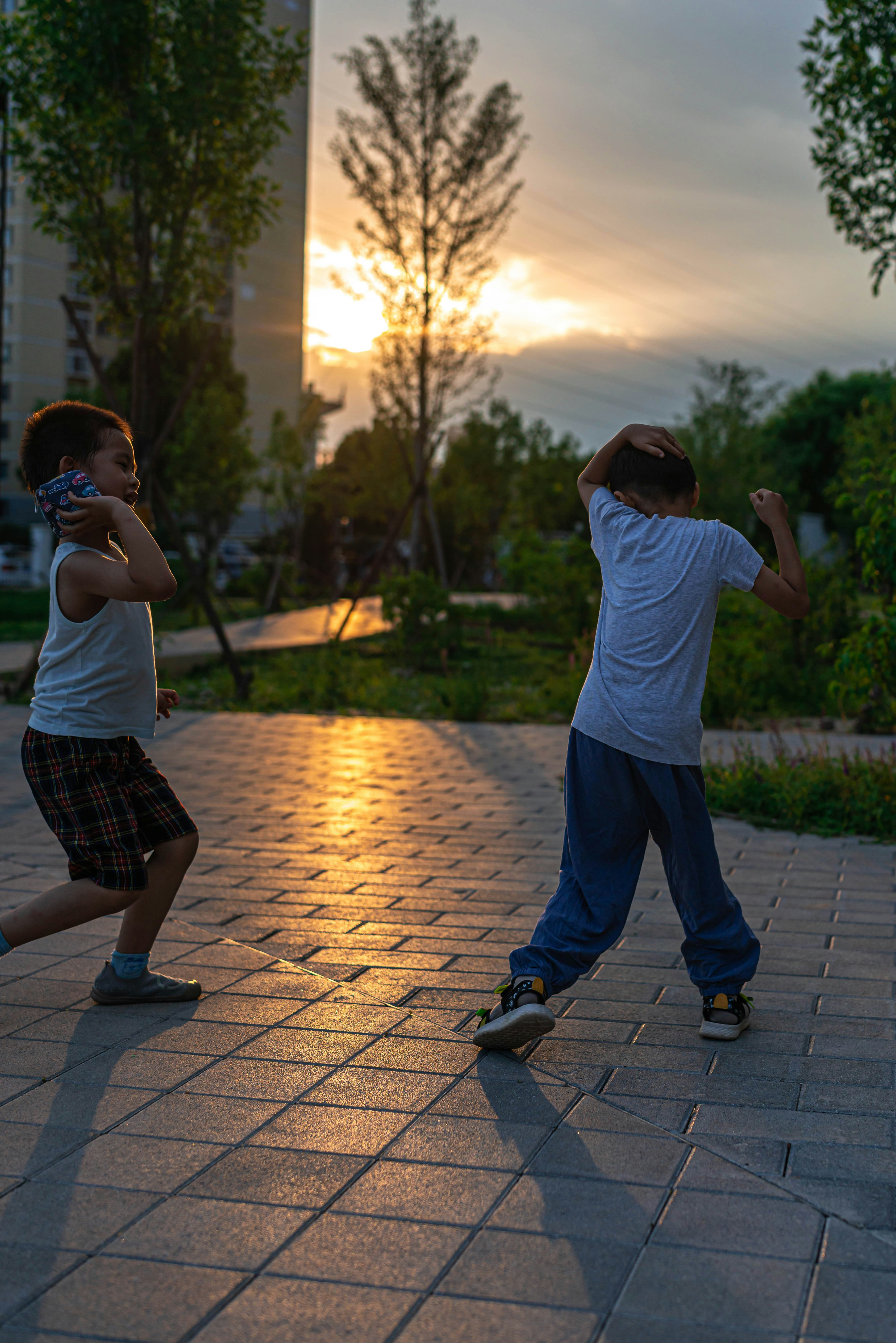 Sunlit chase: kids in motion on a golden plaza