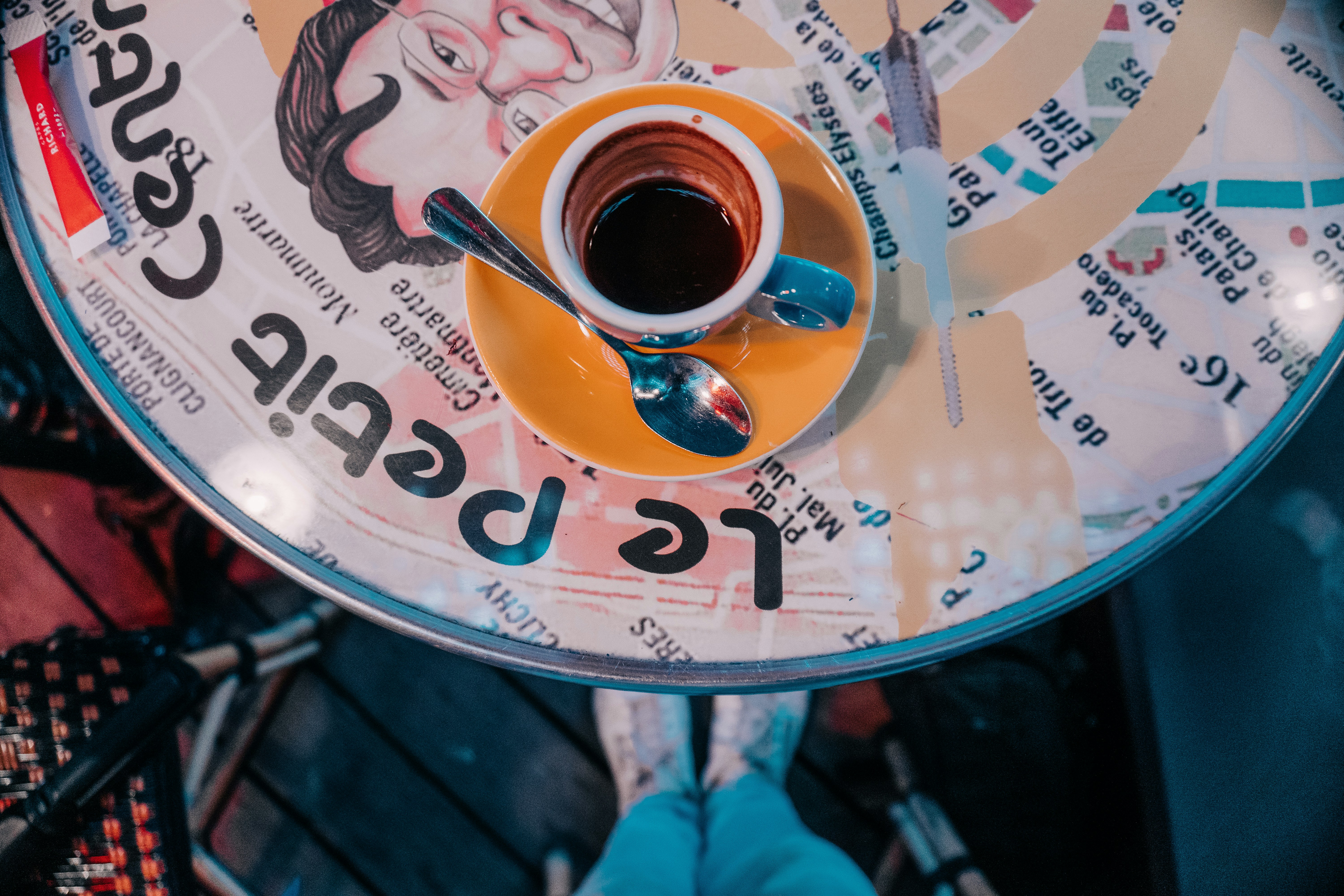 Top-Down Café Moment: Espresso Nestled on a Circular Newspaper Table