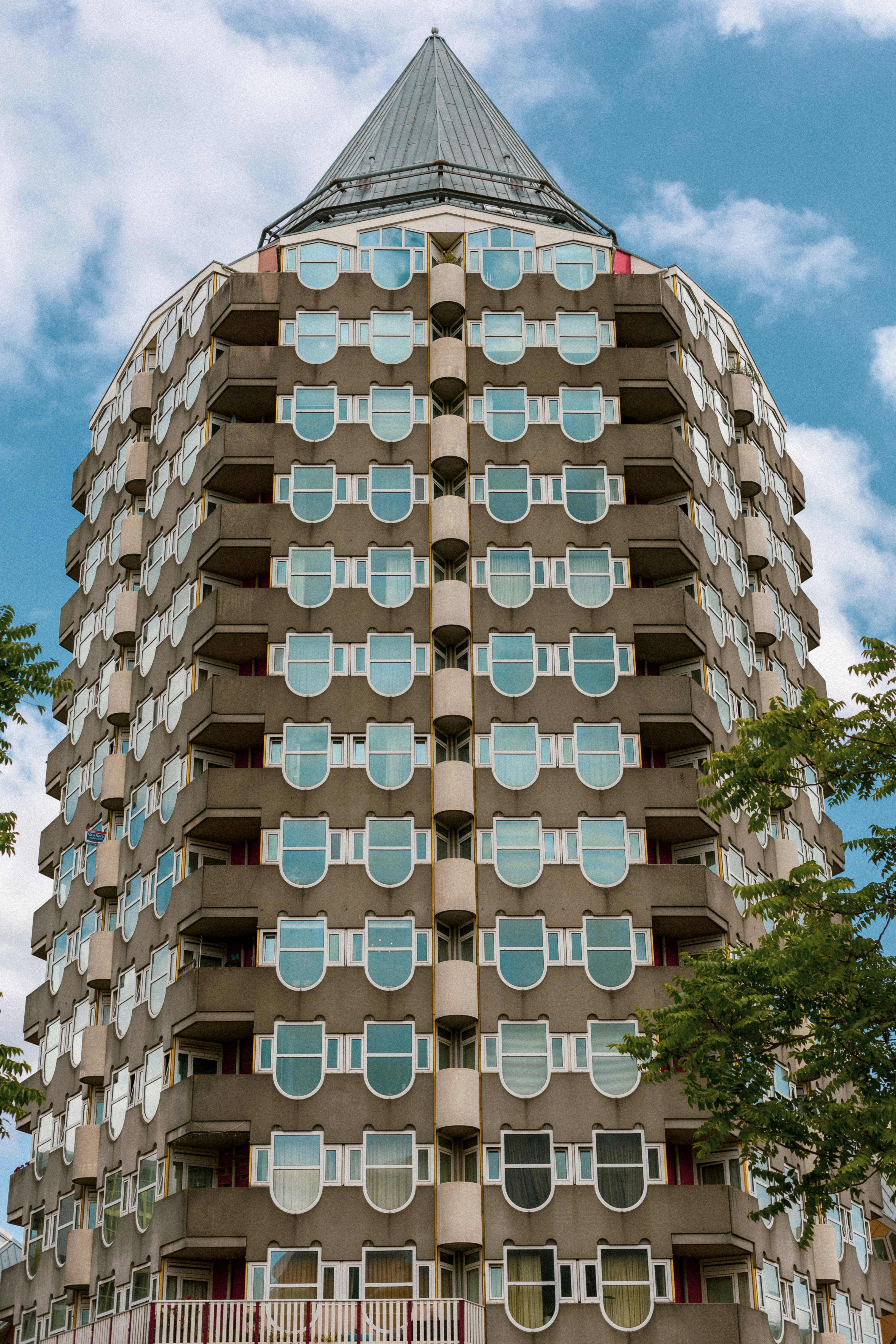 Crescent of Balconies: A Cylindrical Tower with Repeating Glass Pleats