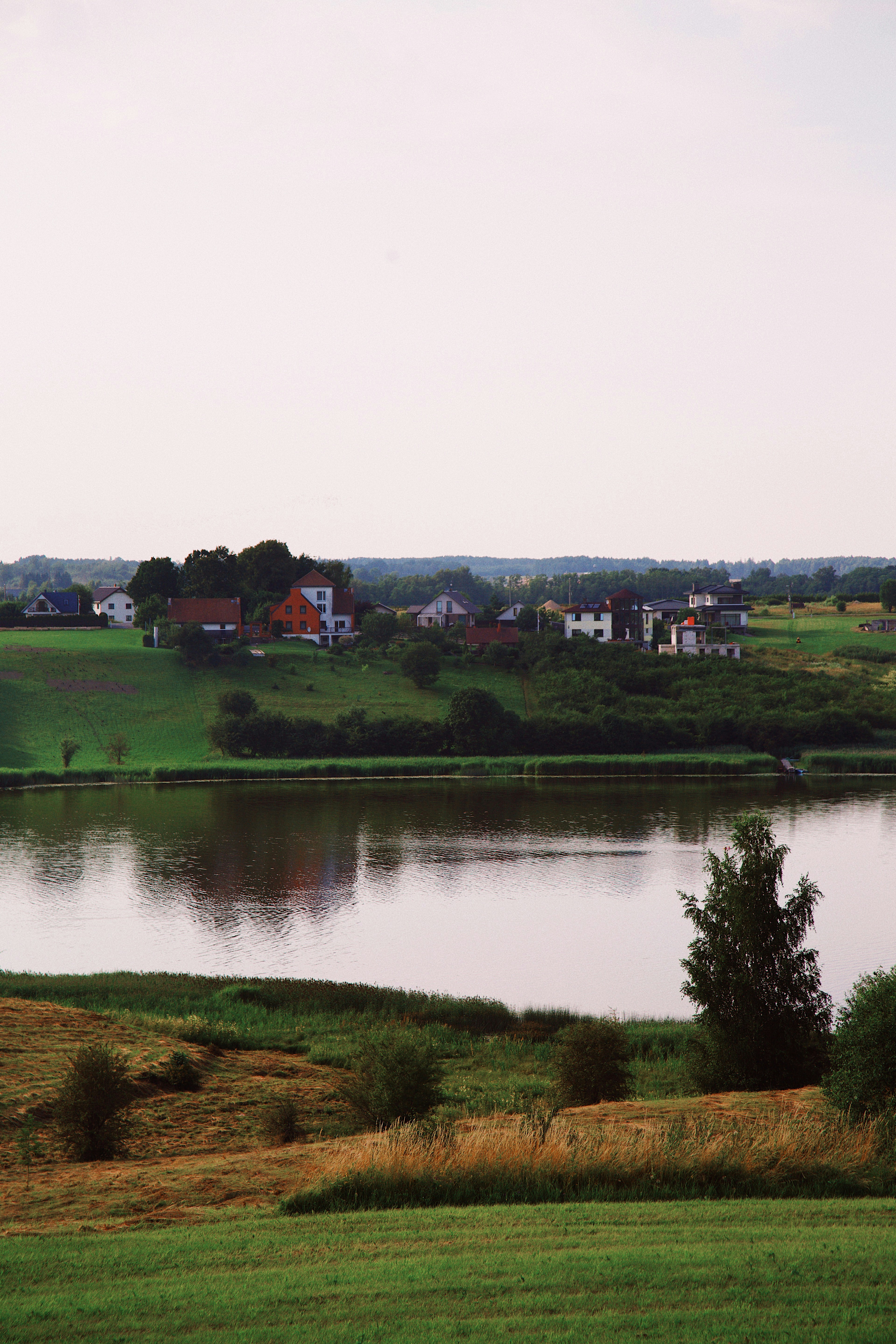 Riverside Village Quietly Framed by Hill andWater