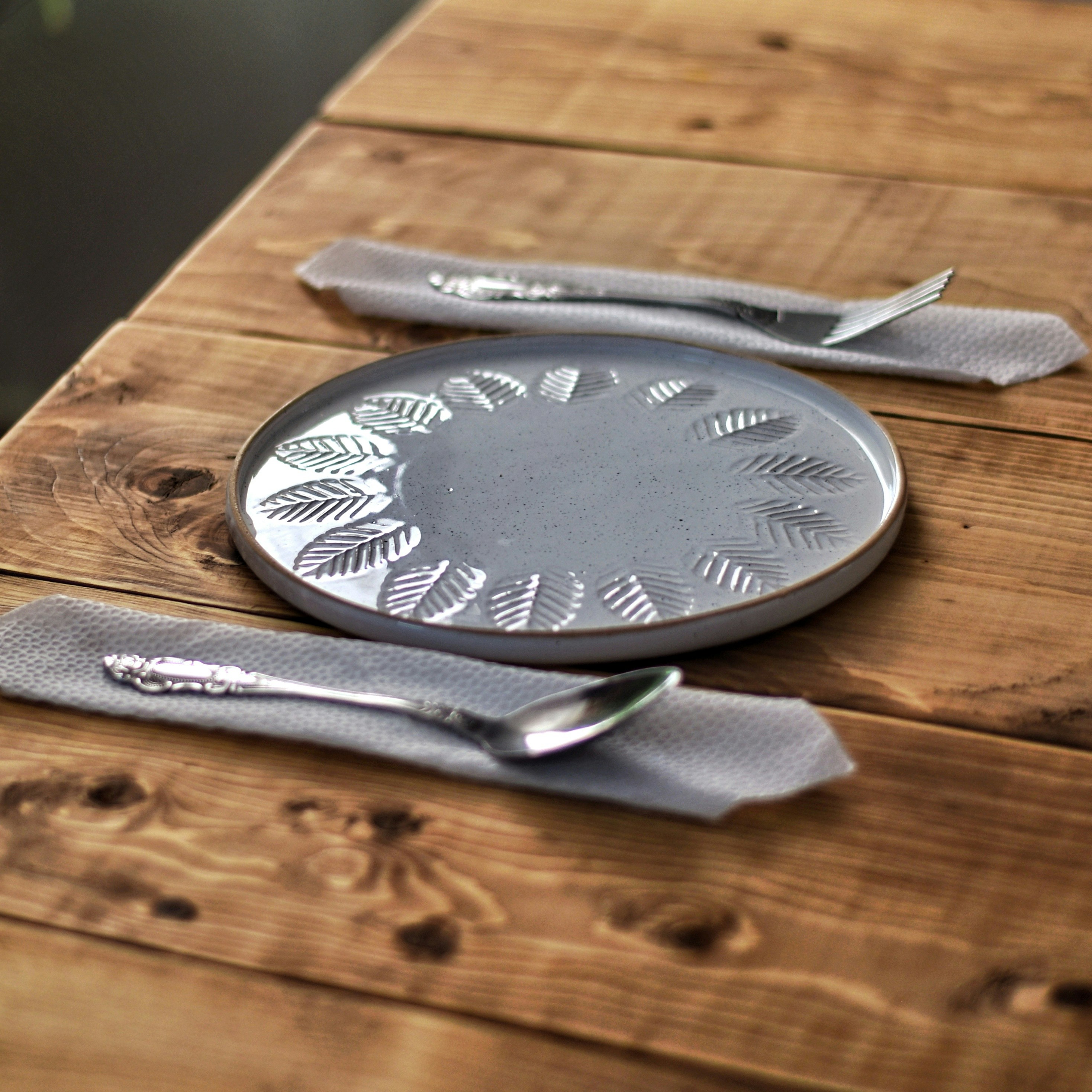 Dimpled Tabletop Pause: A Stainless Coin Tray set between cutlery