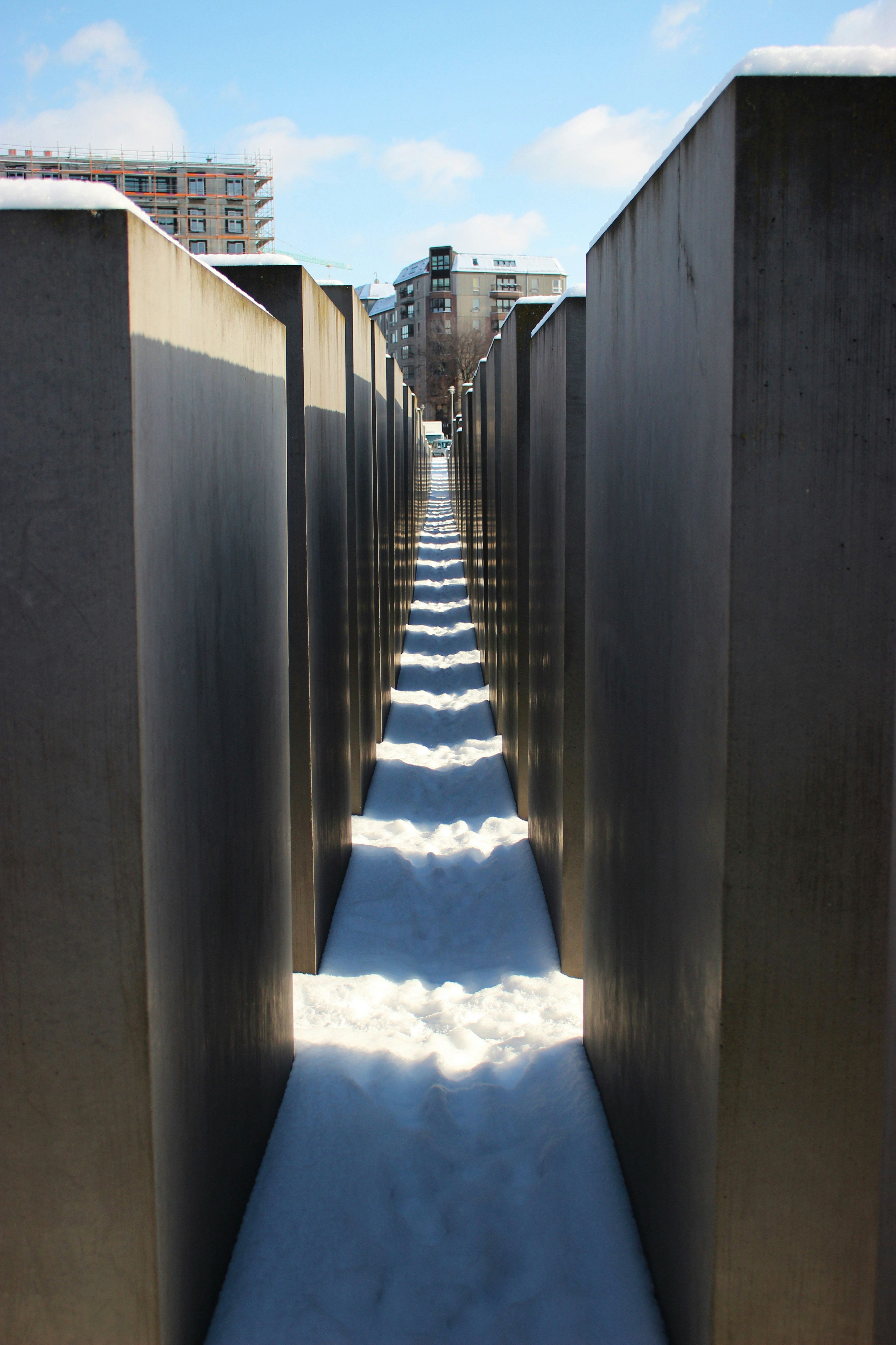 Holocaust Memorial in Berlin with snow | a frozen river between two large concrete containers