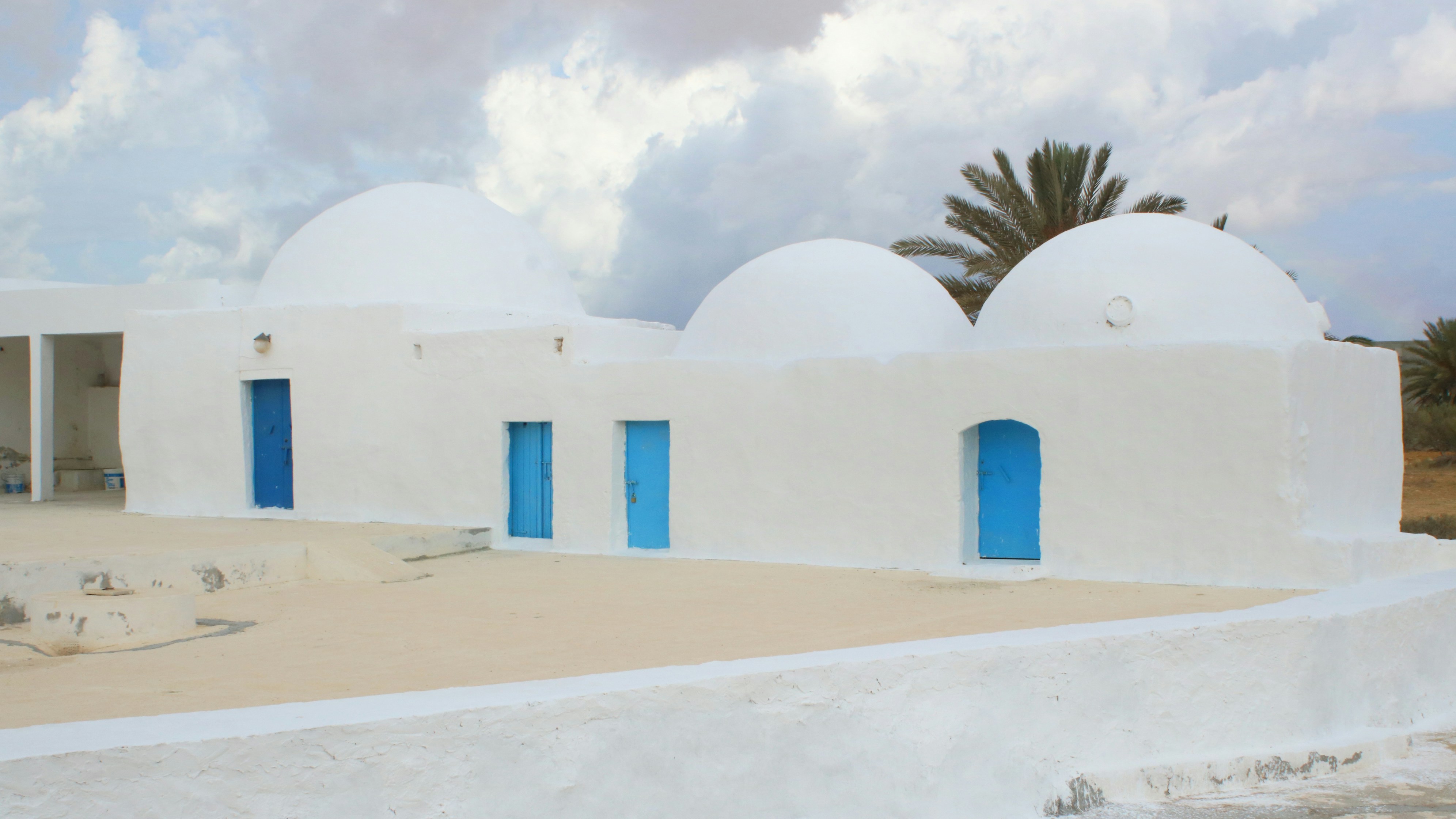 a white building with blue doors