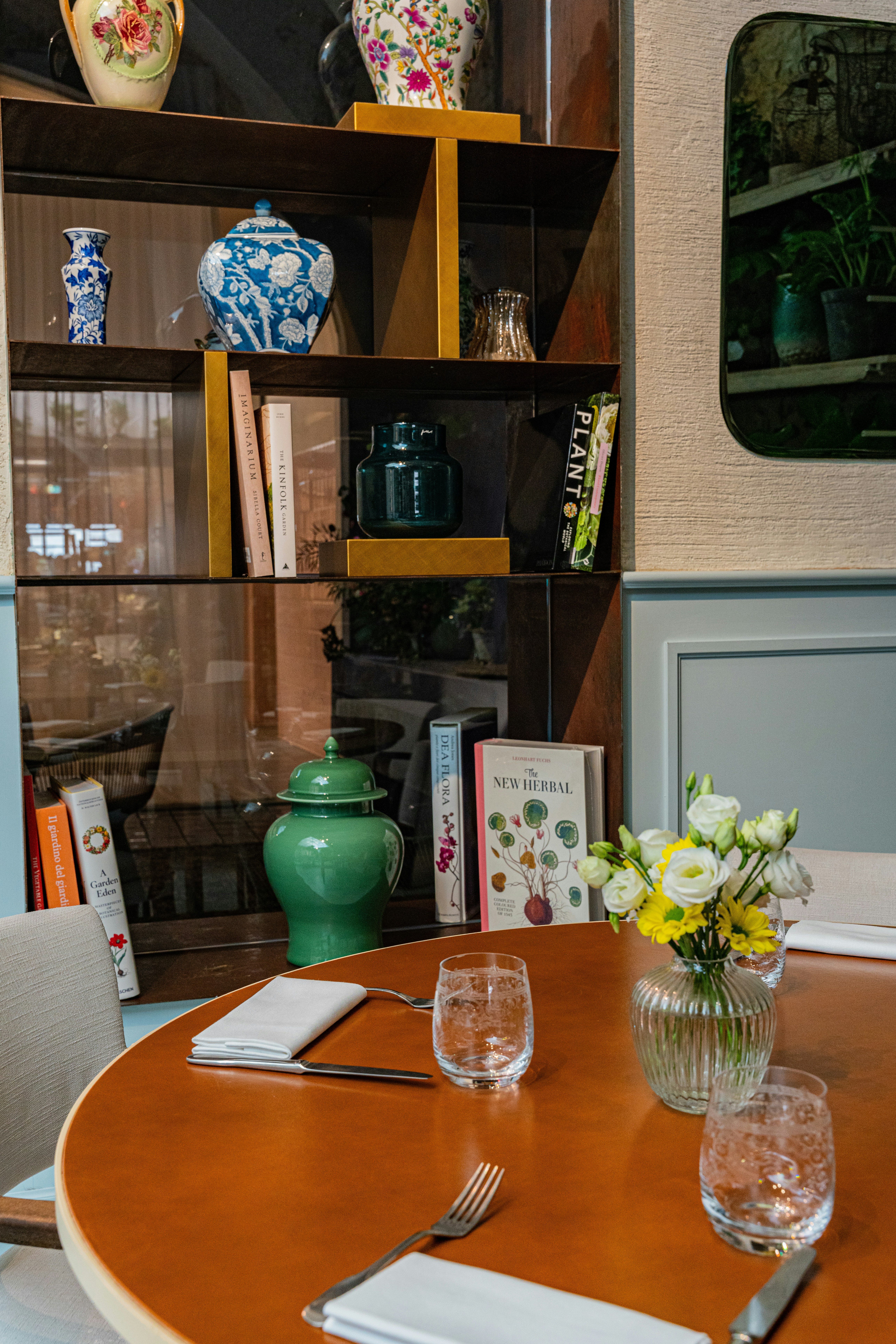 Charming Tea Table Adorned with Floral Arrangement and Decorative Shelves