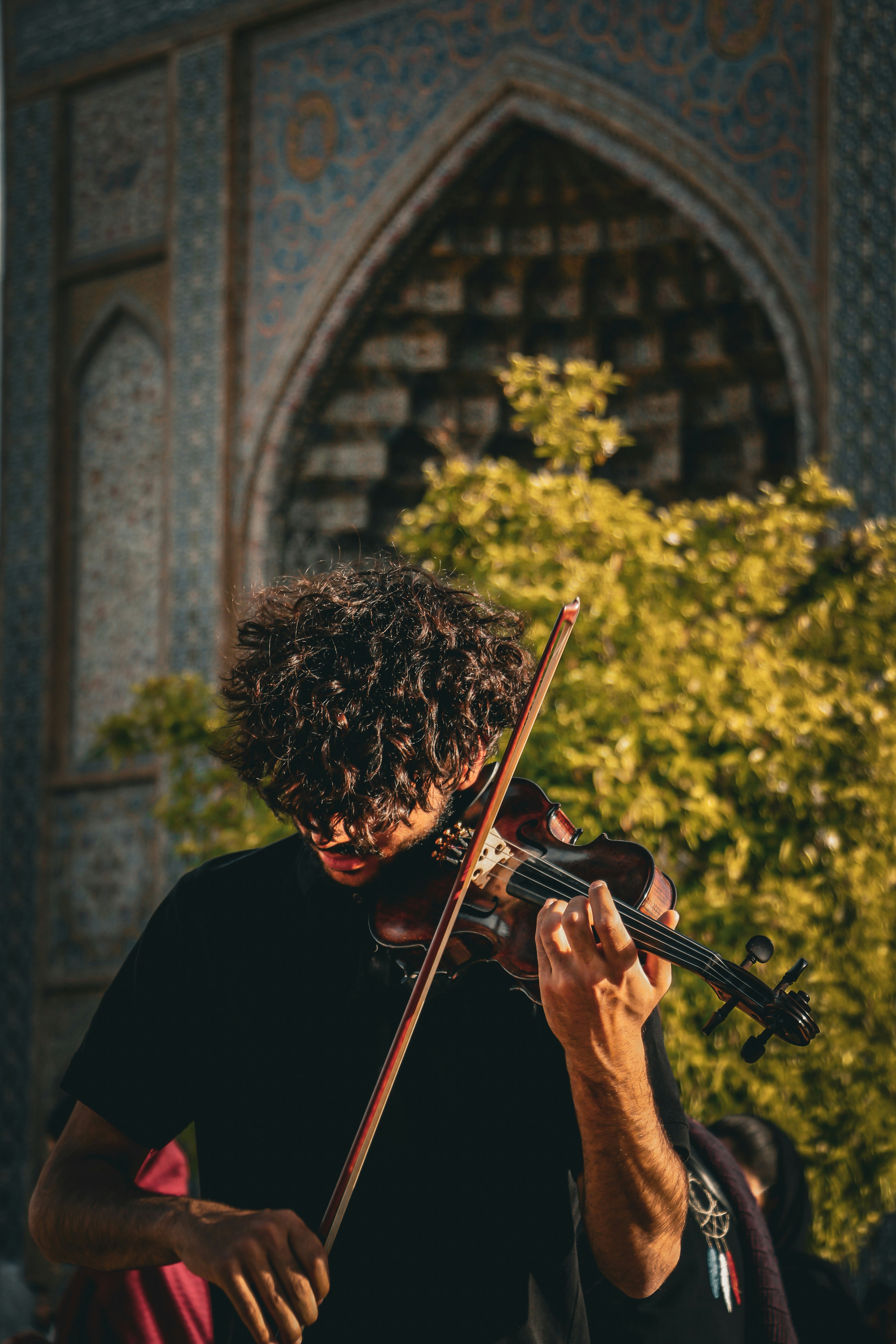 A person playing a violin photo – Free Portrait Image on Unsplash