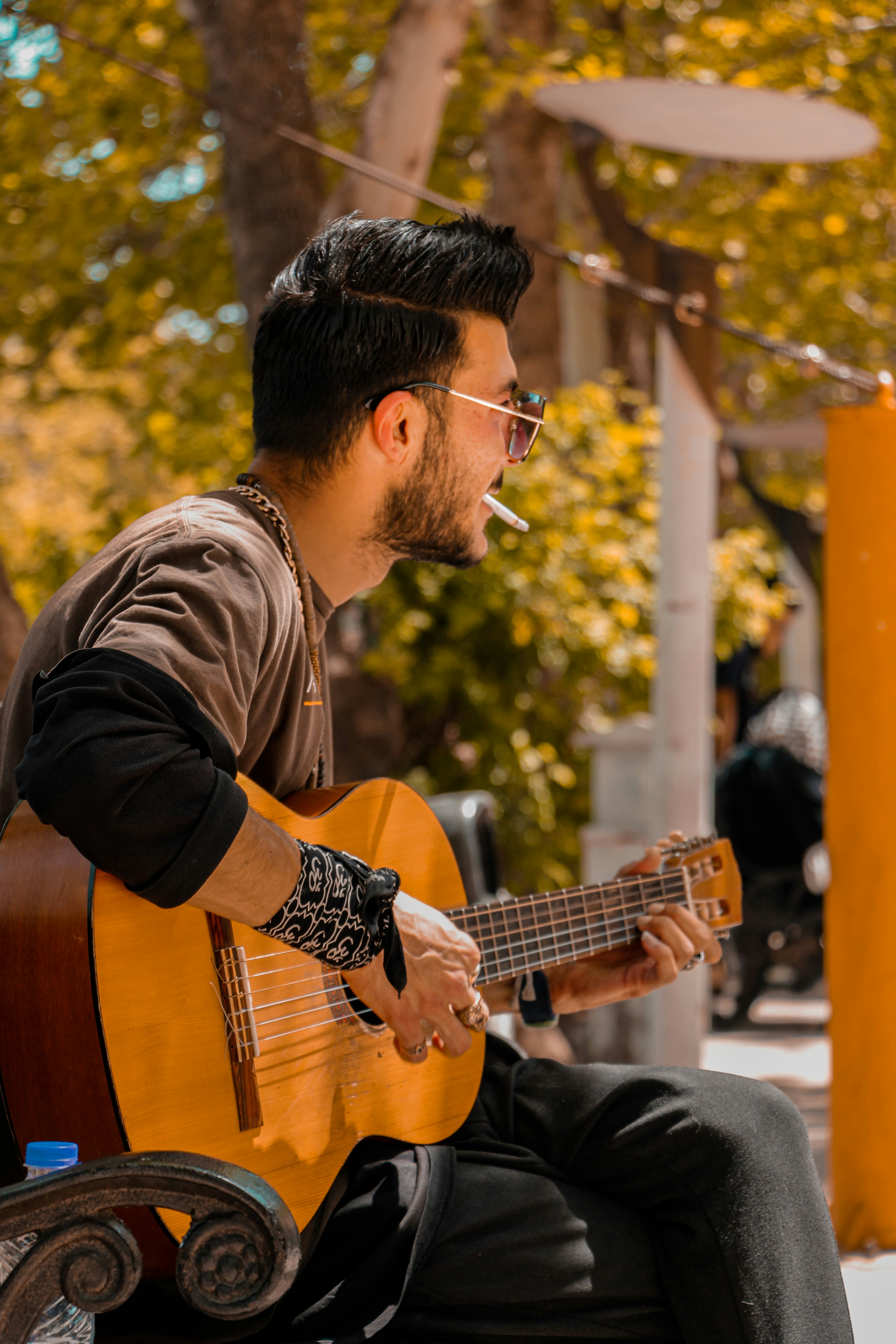 Autumn Street Serenade: Guitarist in Sunlit Leaves