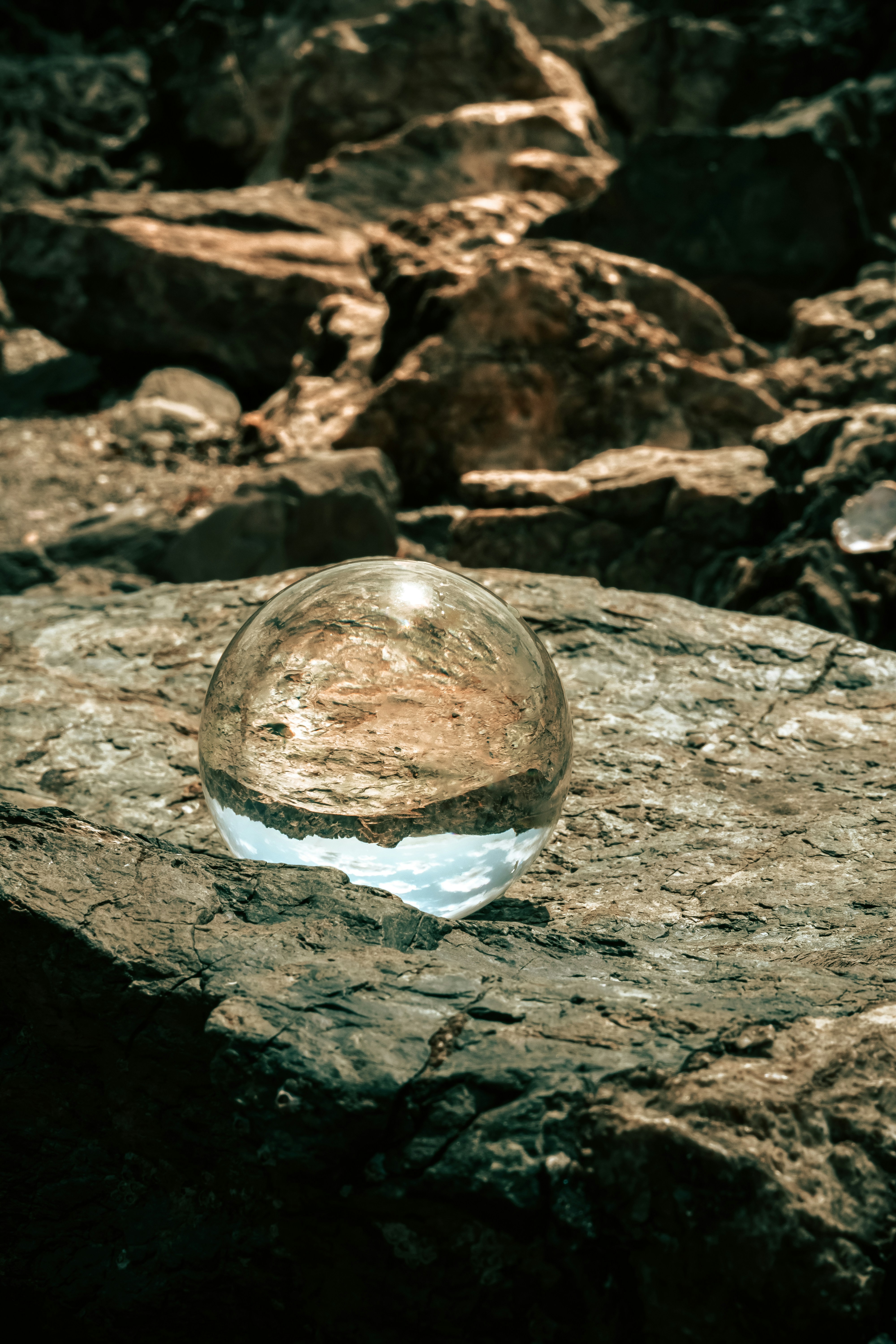 Crystal Ball on Rugged Stone: A Quiet Sky Reflected in Glass