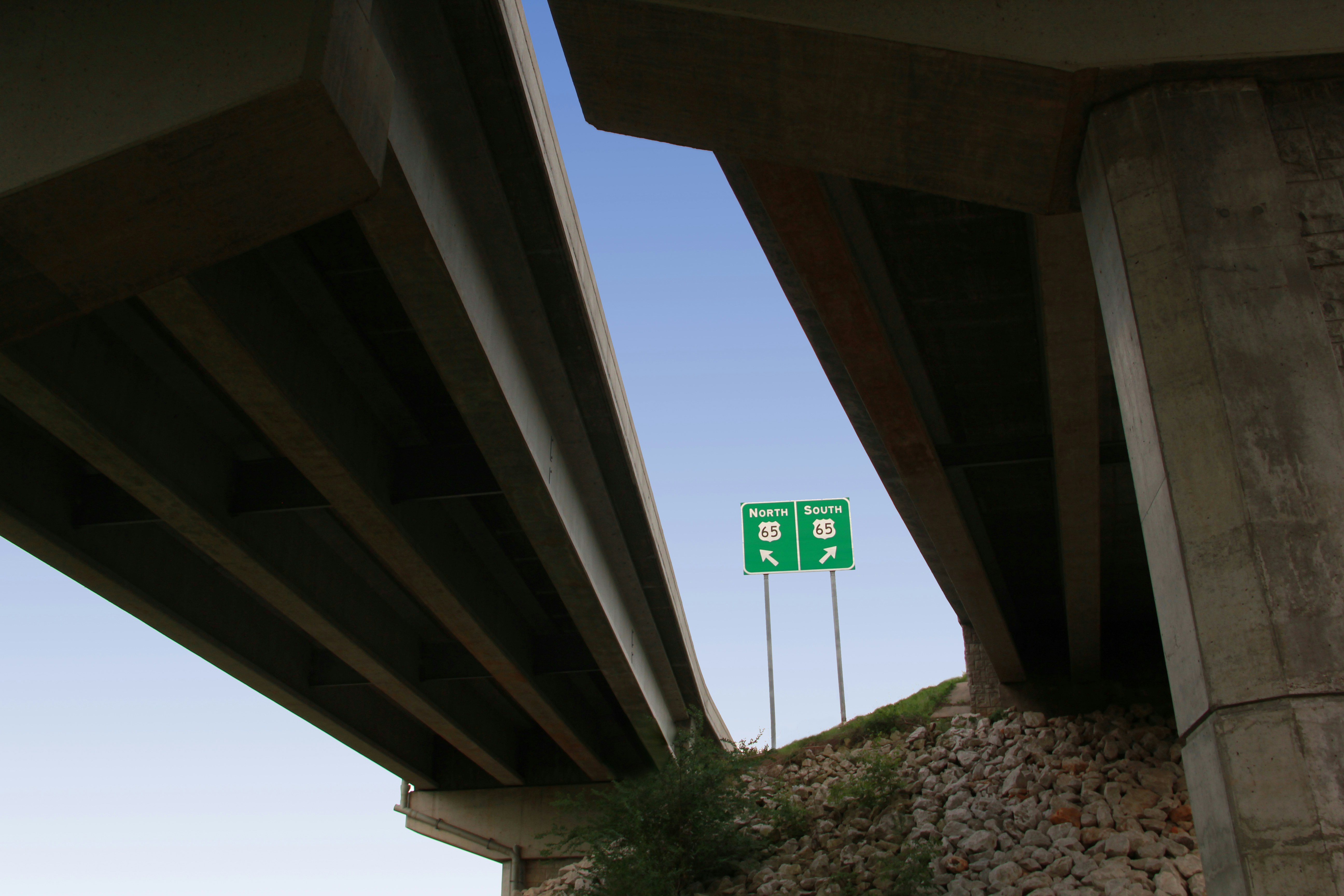 A sign on a bridge photo – Free Blue Image on Unsplash