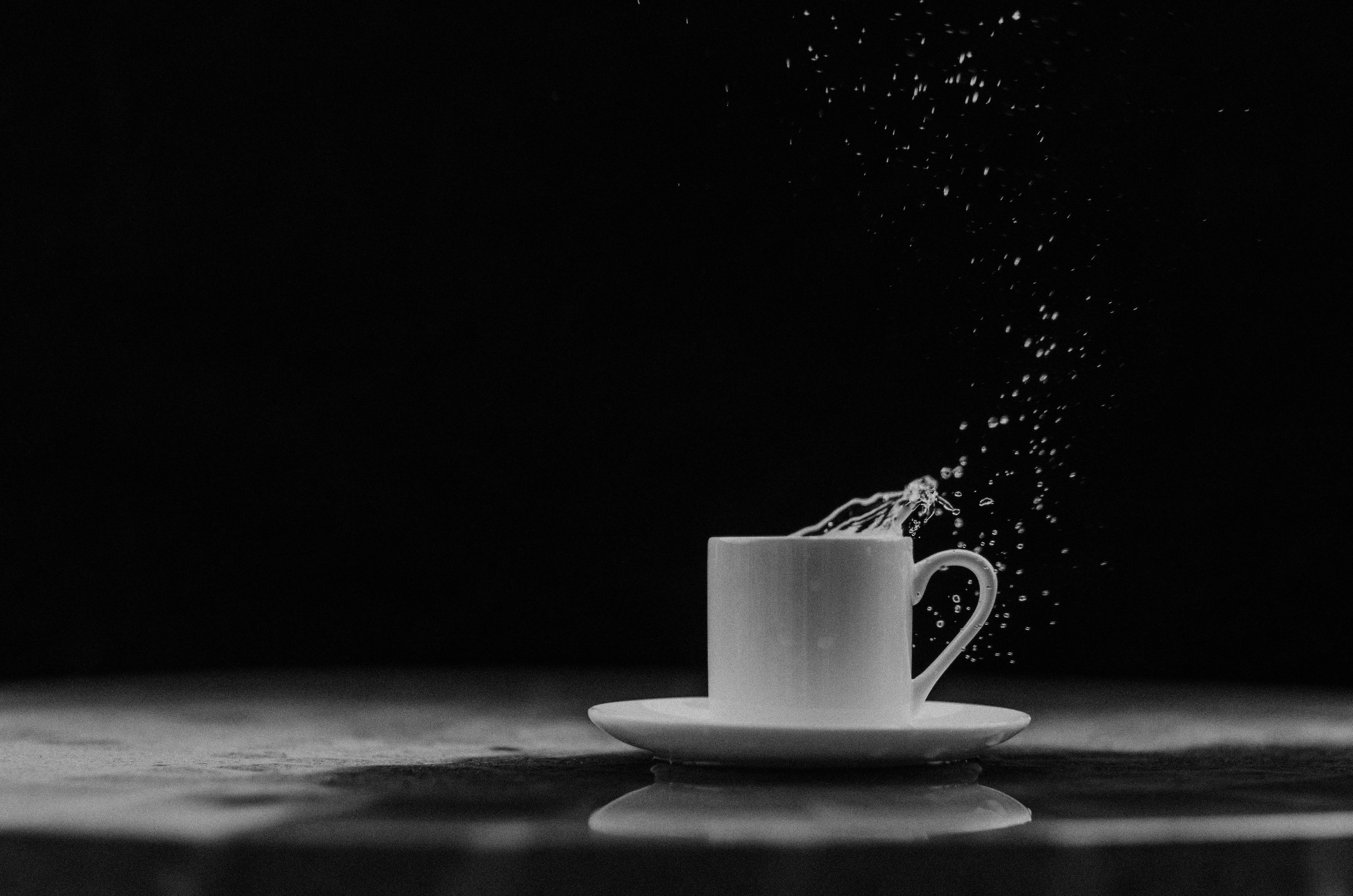 Whisper on White: a solitary cup erupts in a quiet splash