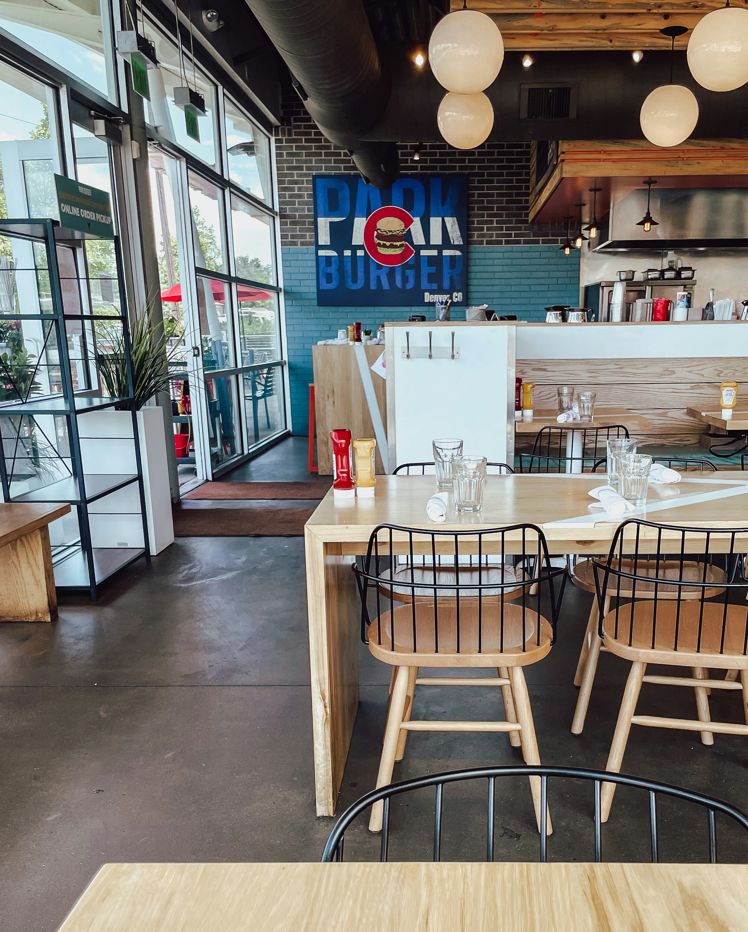 Burger Sign Above a Sunlit Modern Café Interior