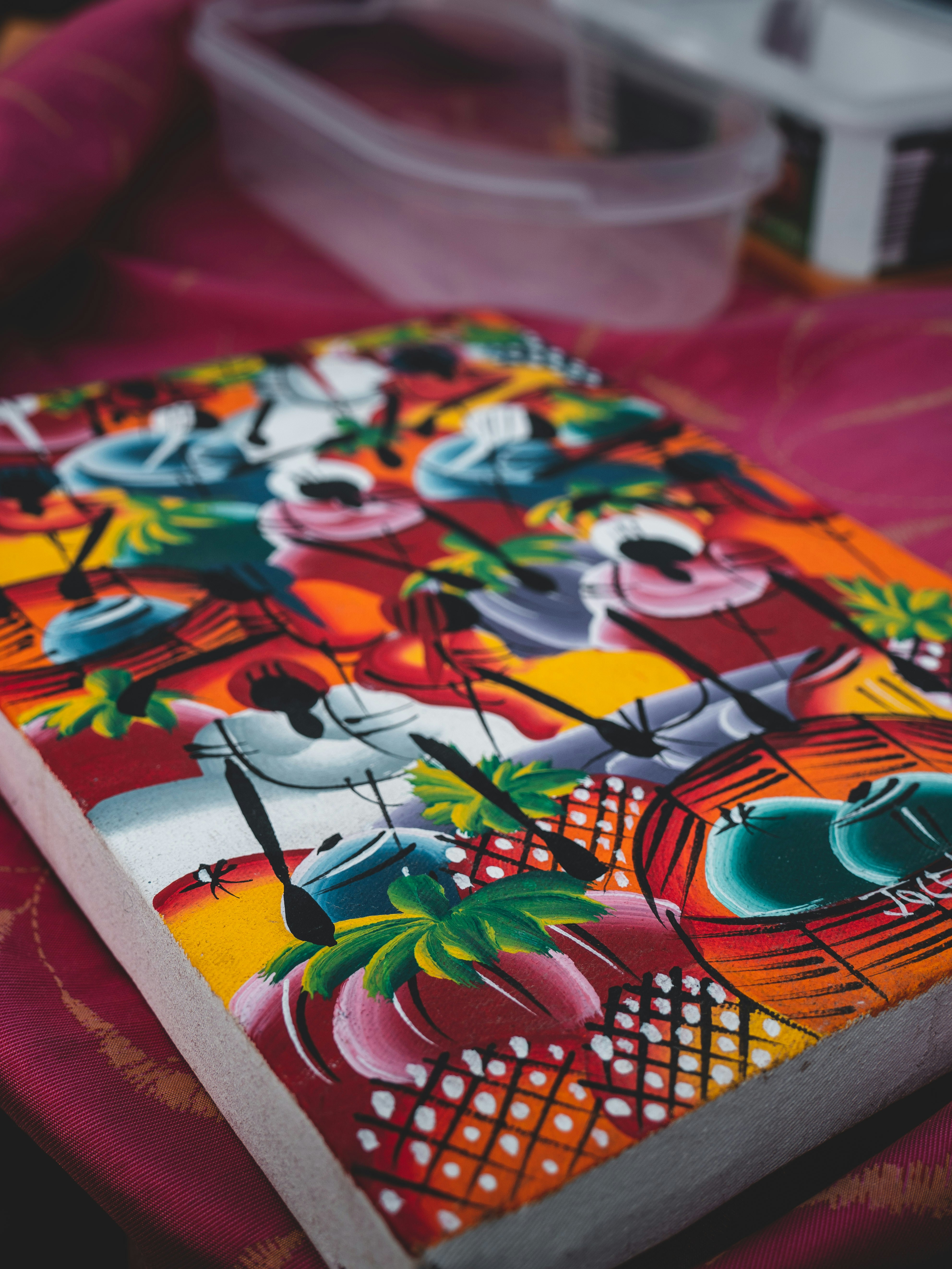 Tropical Carnival on the Page: A Colorful Notebook Resting on Fabric