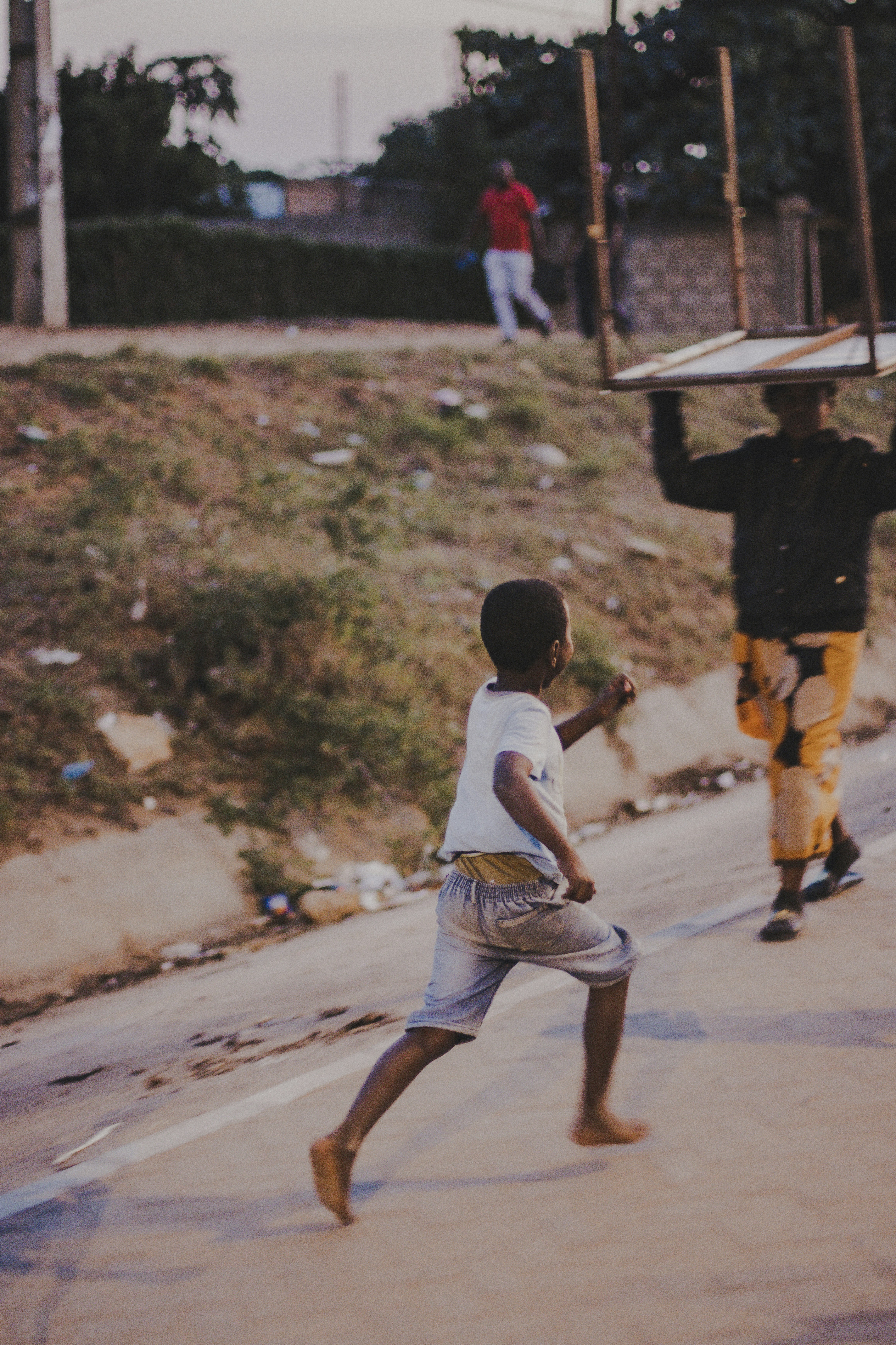 Barefoot Dash on a Dusty Street: A Moment of Urban Motion