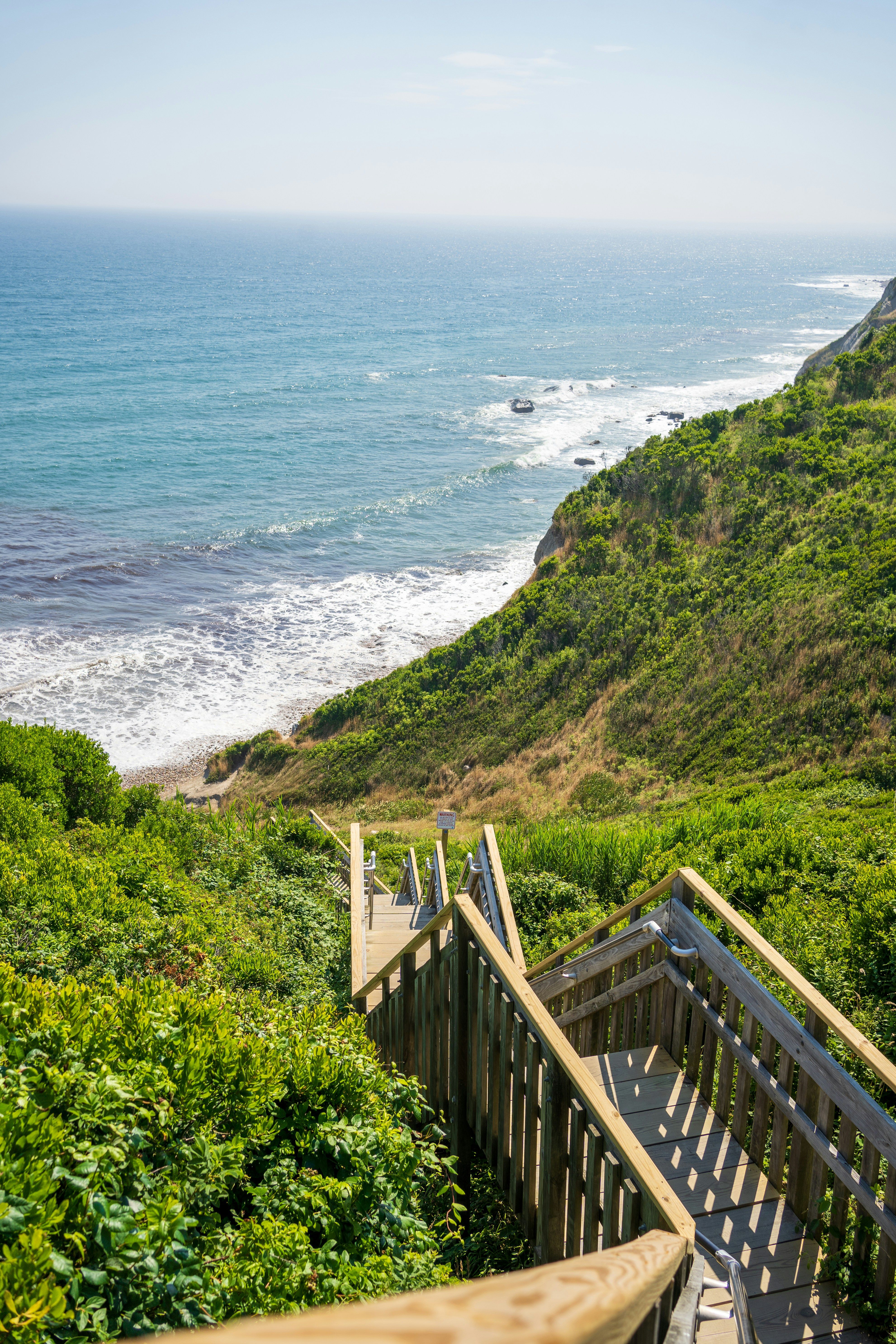 A wooden railing overlooking a beach photo – Free Handrail Image on ...
