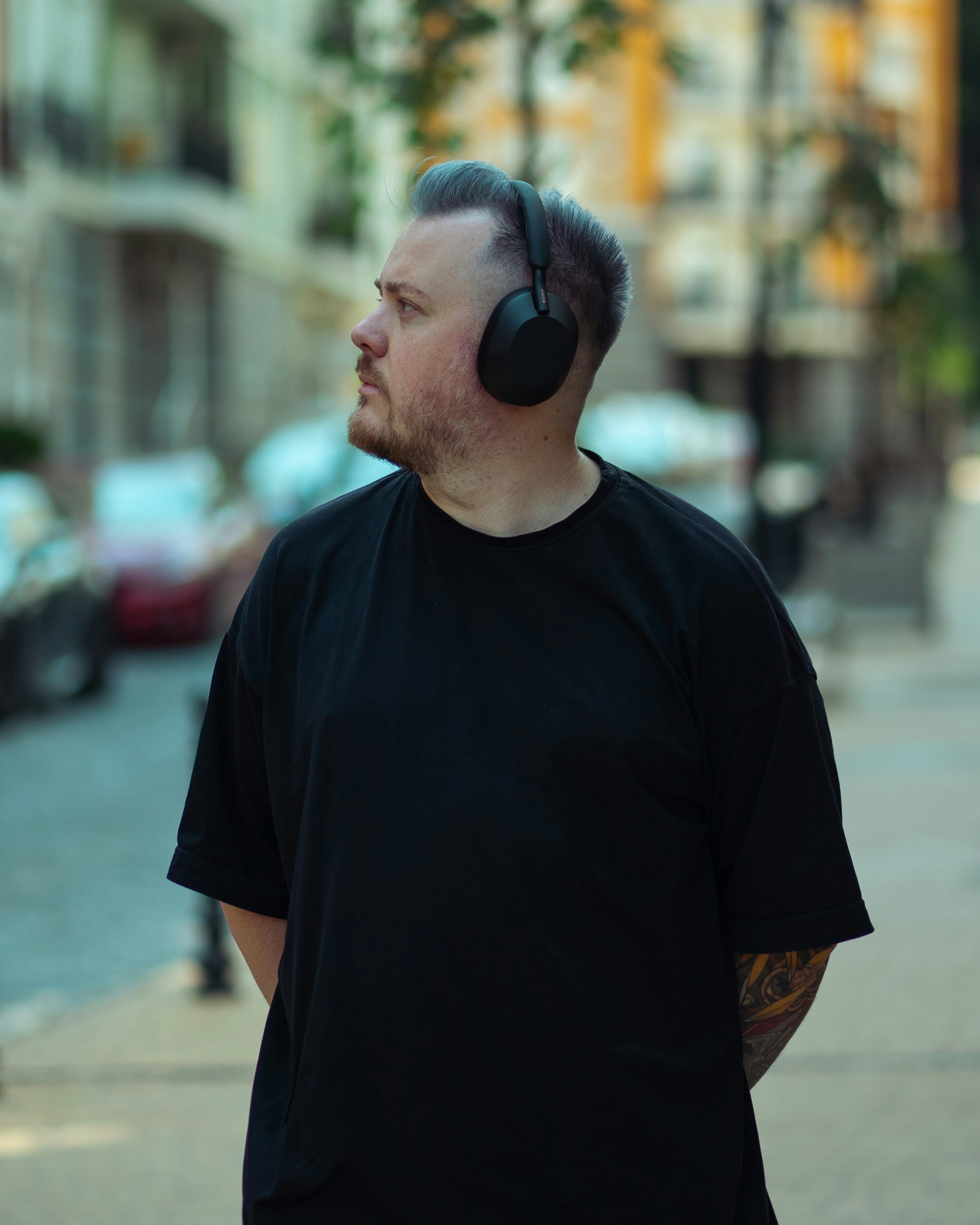 Headphones in the City: A Quiet Portrait Amid Urban Blur