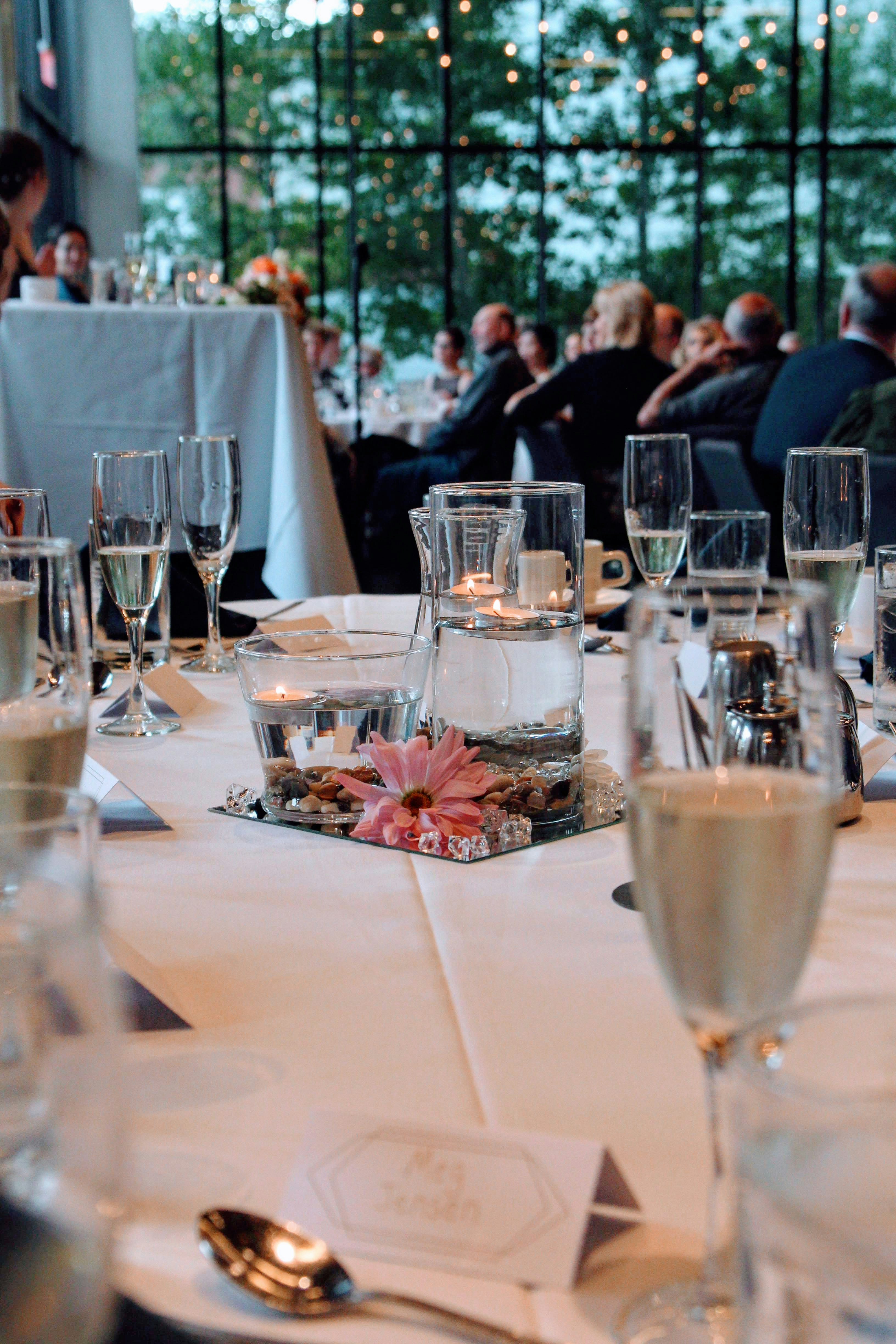 Table setting featuring elegant glassware and a floral centerpiece, capturing a moment of celebration at a gathering.