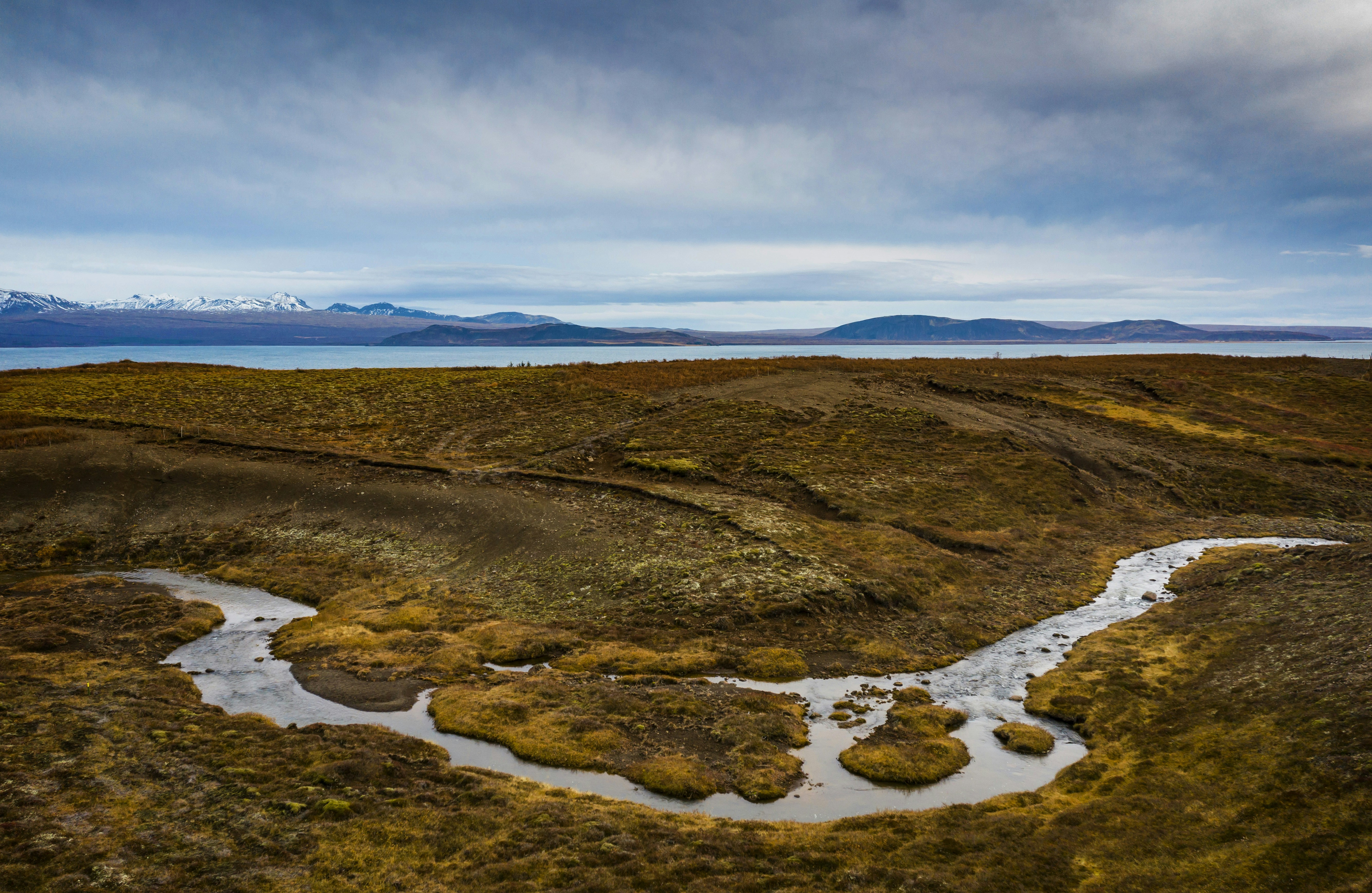 A large area of land with water and a body of water in the distance ...