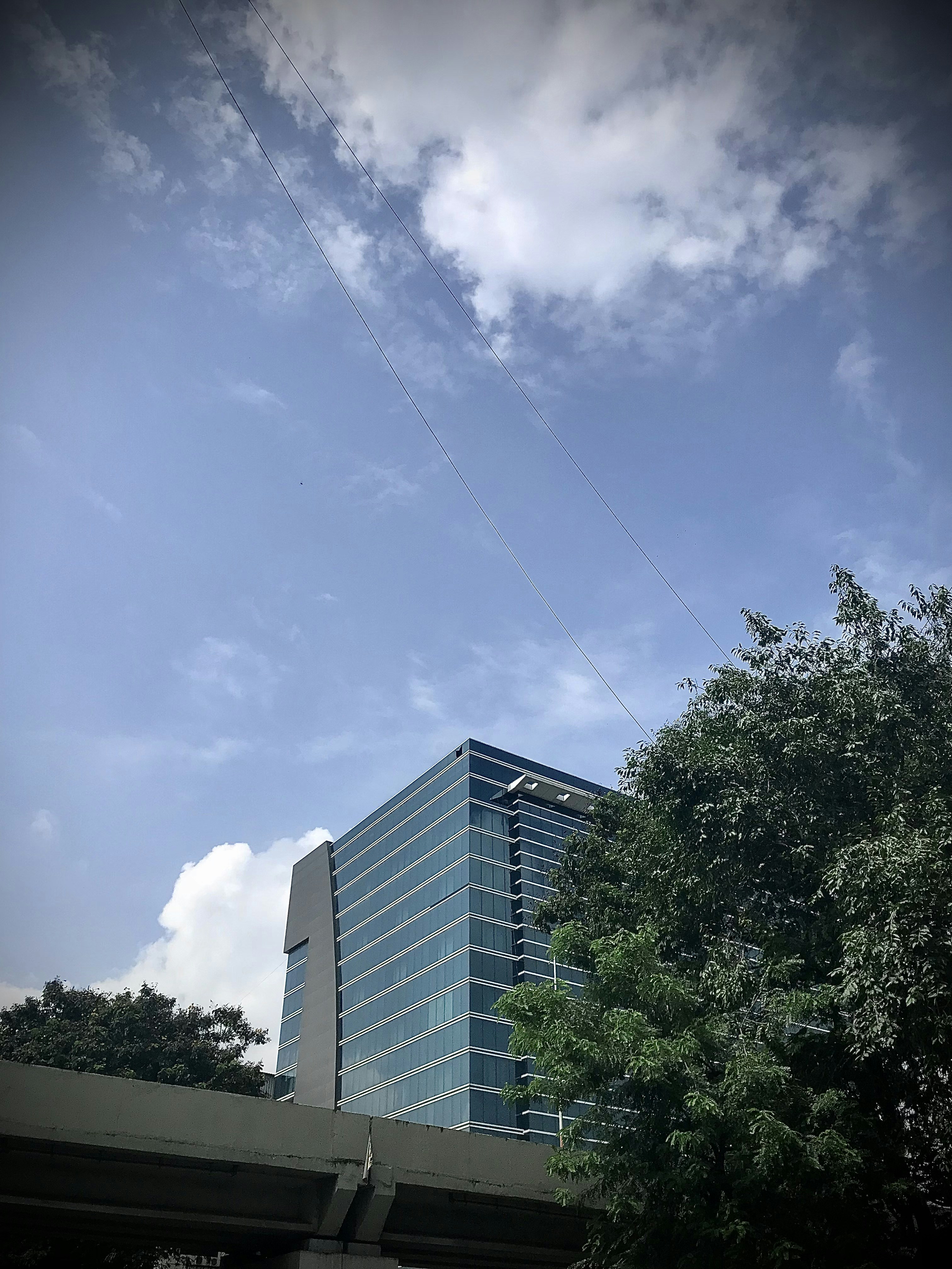 a building with a blue sky and clouds above it