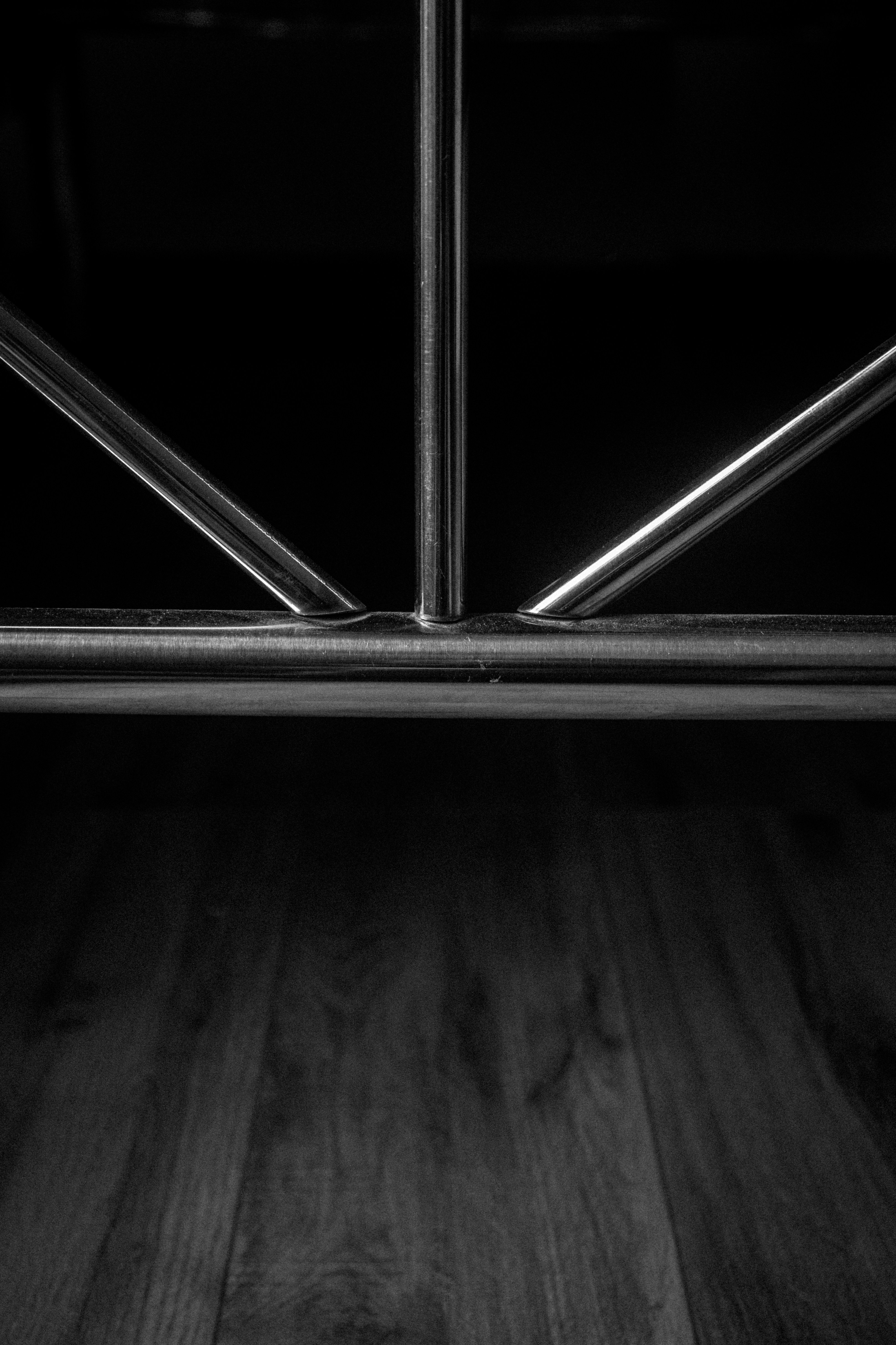 Chromed Rails Converge at the Floor