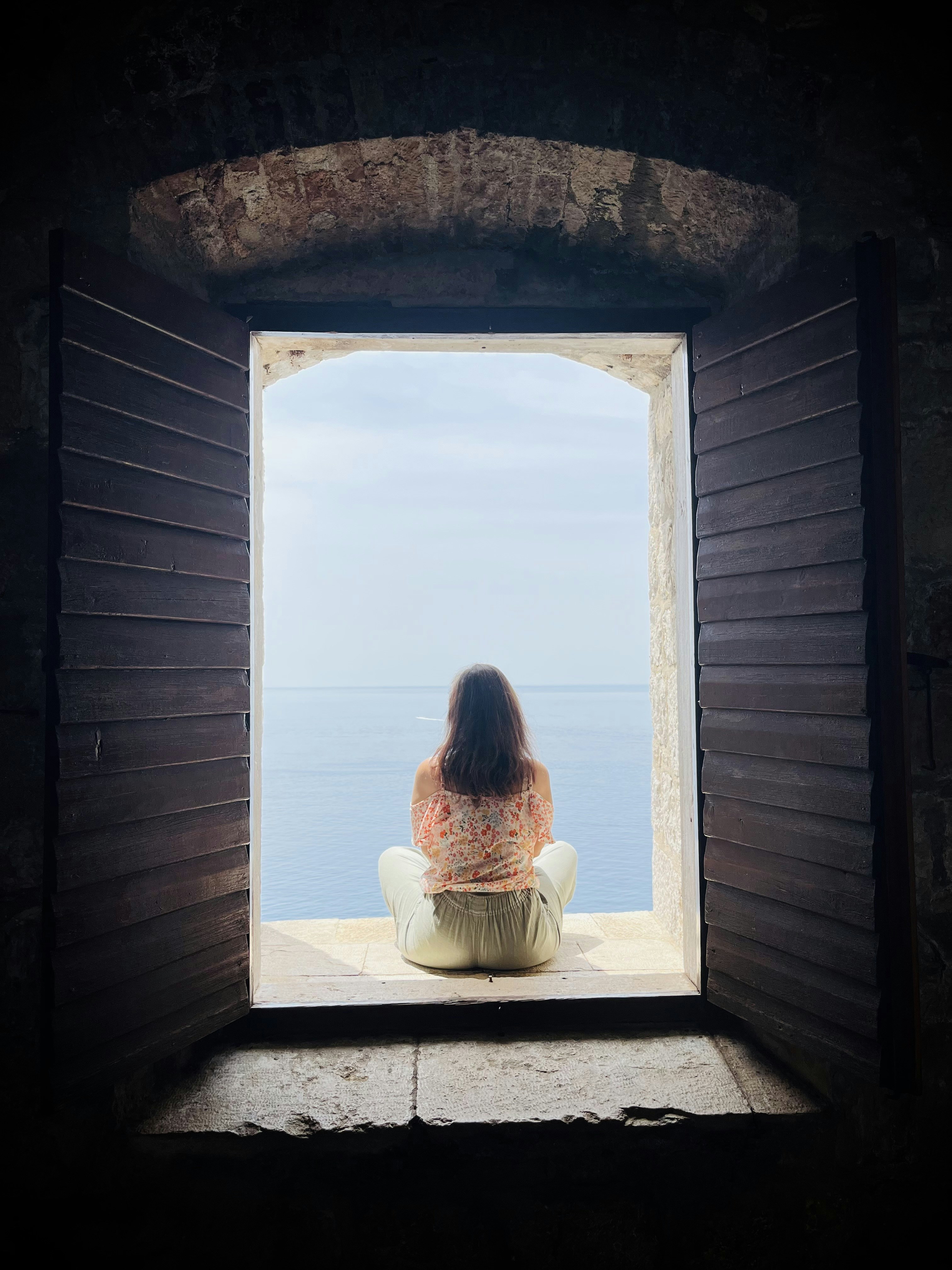 Seated by the Sea: A Quiet View Through a Coastal Window