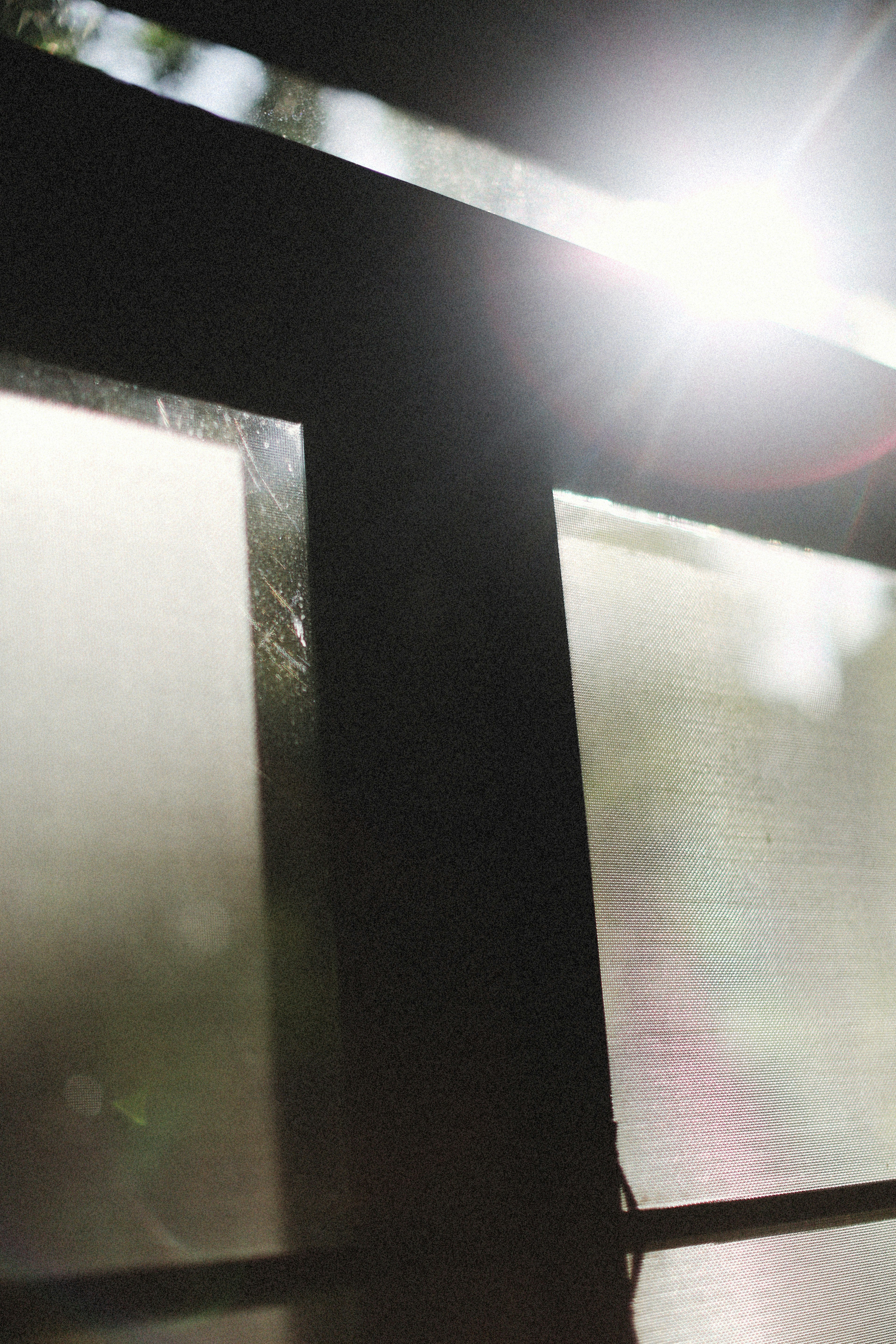 Sunburst Through Framed Glass: Geometry, Light, and Glare